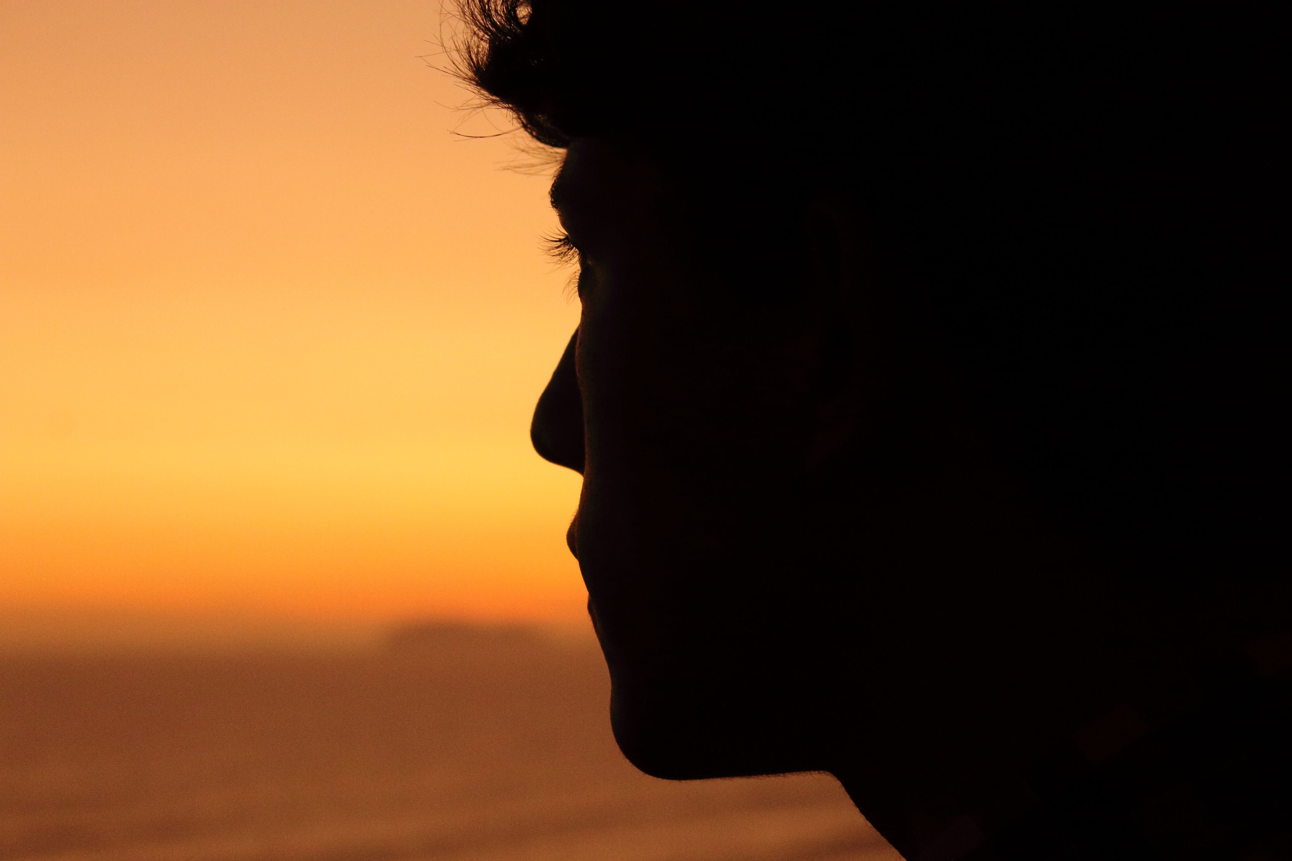 Silhouette of a Boys Profile against Sunset Sky · Free Stock Photo