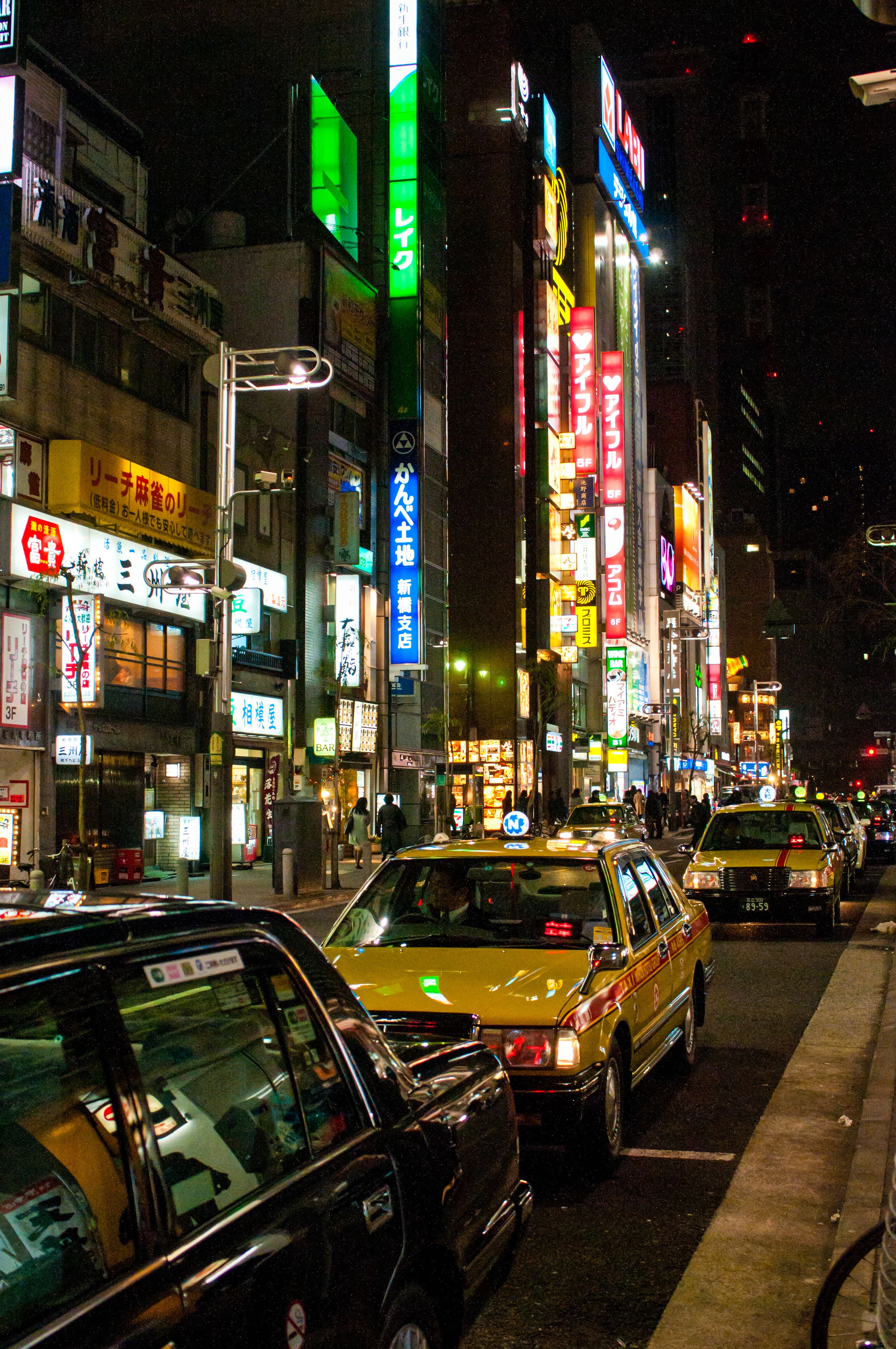 Vibrant Nightlife with Taxis in Urban Street Scene · Free Stock Photo