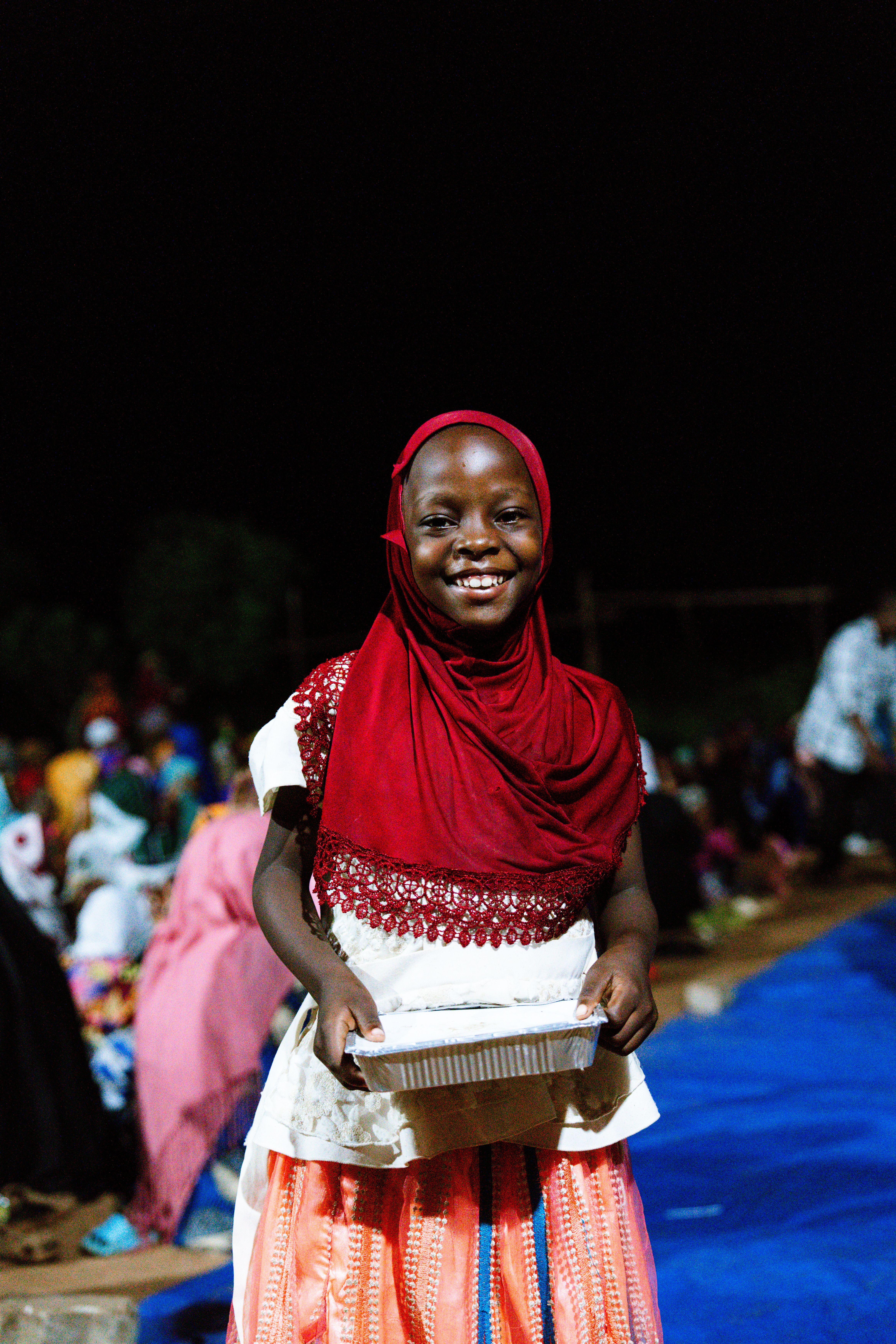 Smiling Girl in Red Hijab at Night Gathering · Free Stock Photo