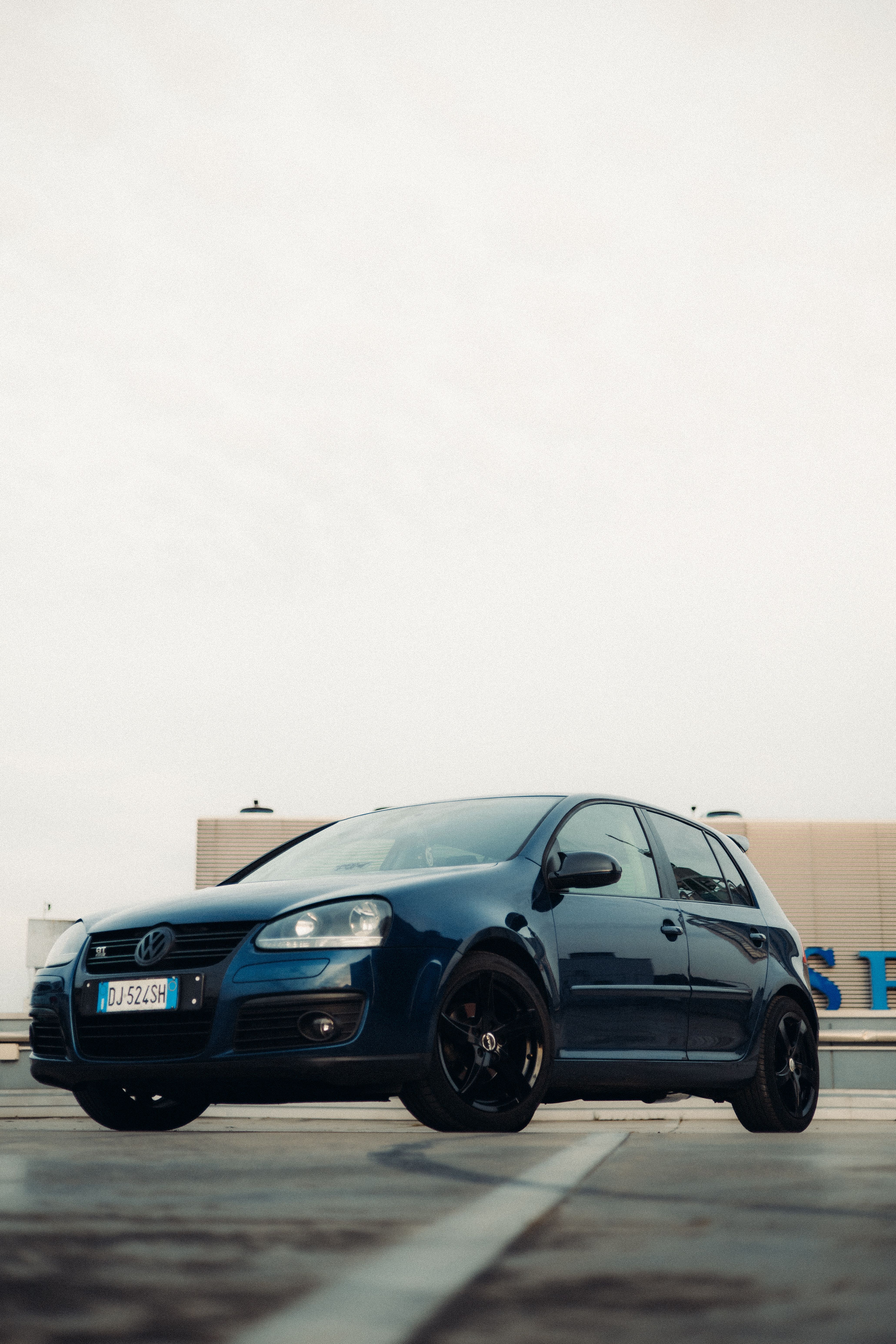 Stylish Blue Car on Urban Roadway · Free Stock Photo