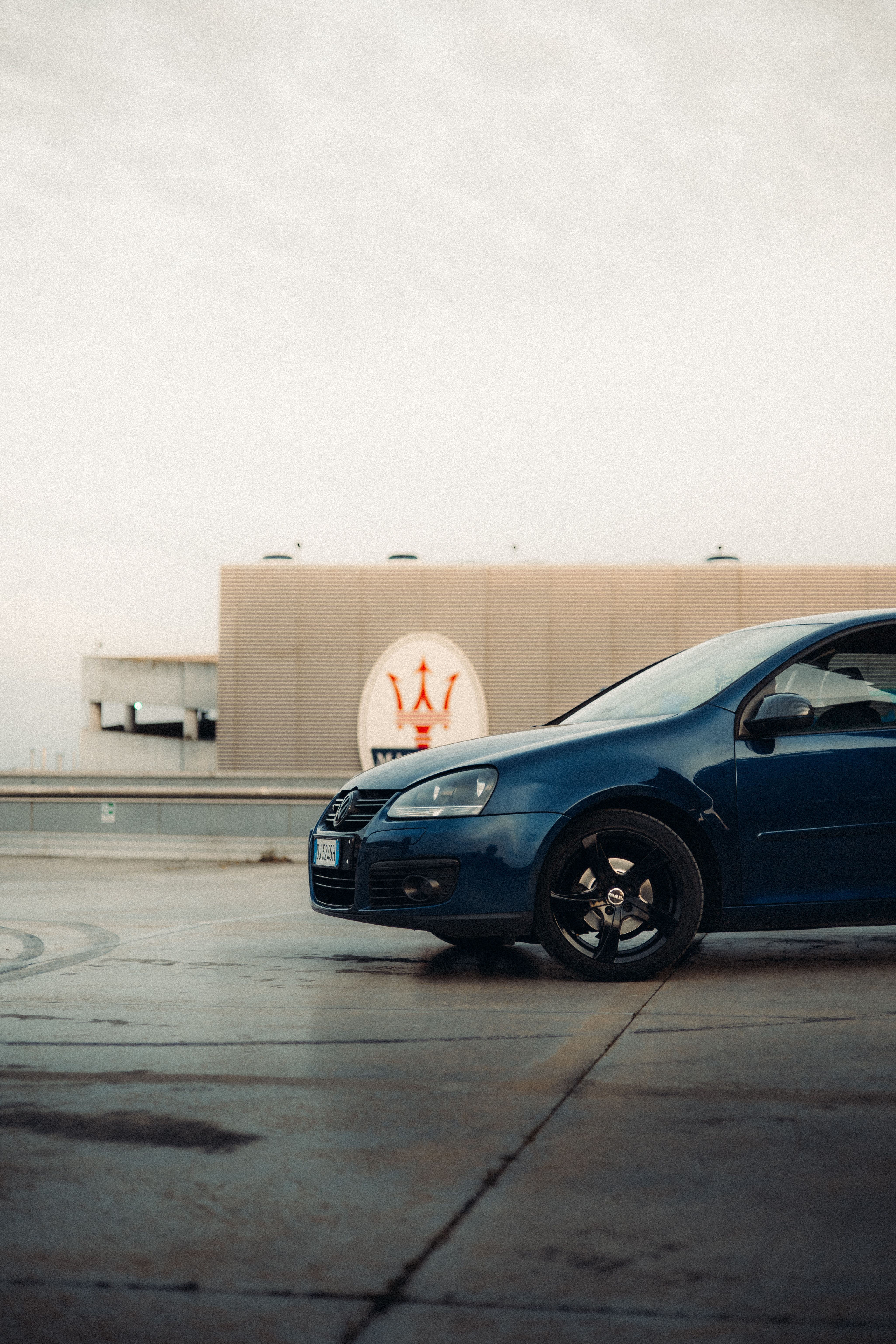 Blue Car on Urban Rooftop with Overcast Sky · Free Stock Photo