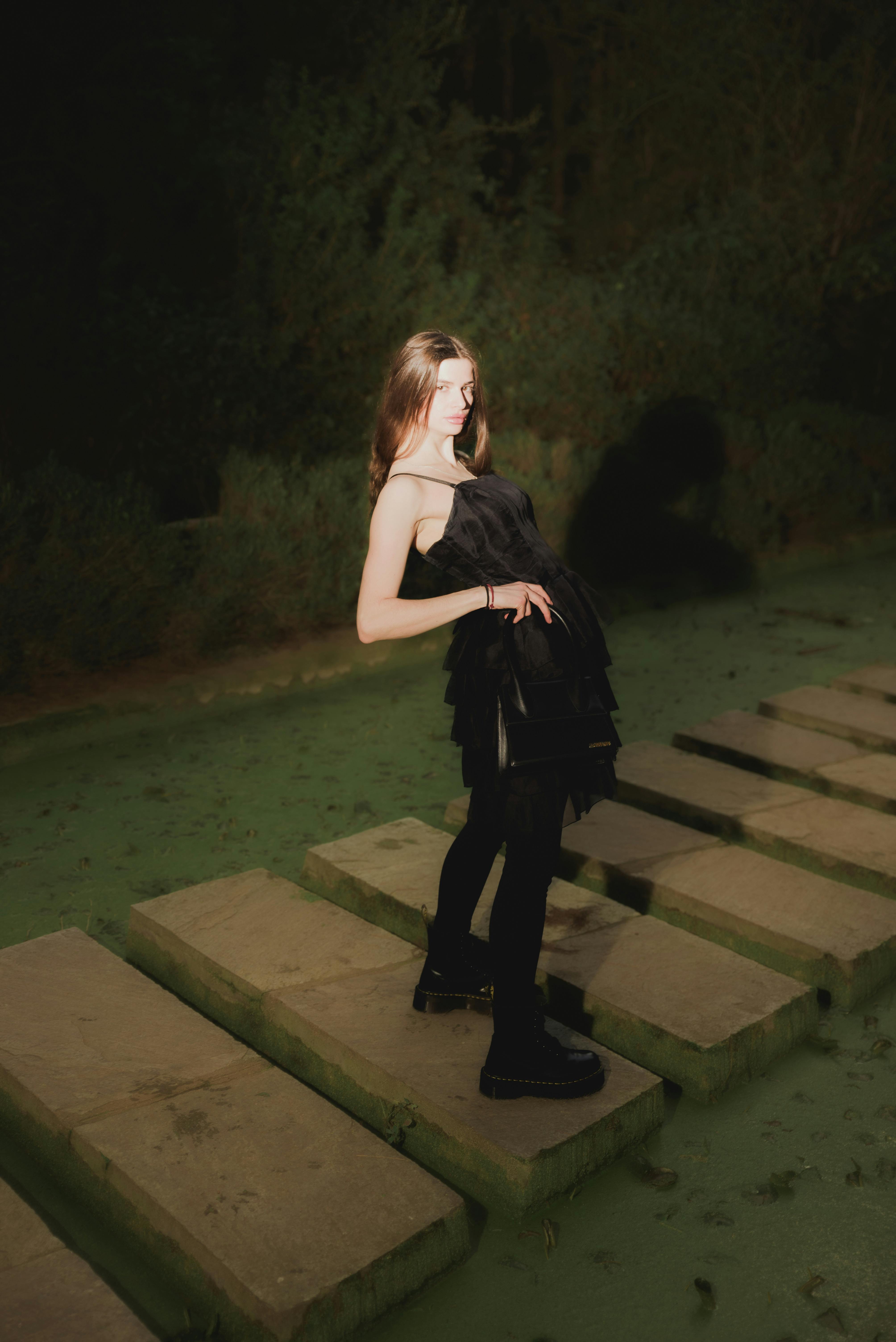 Woman Posing Stylishly on Stone Path at Night · Free Stock Photo