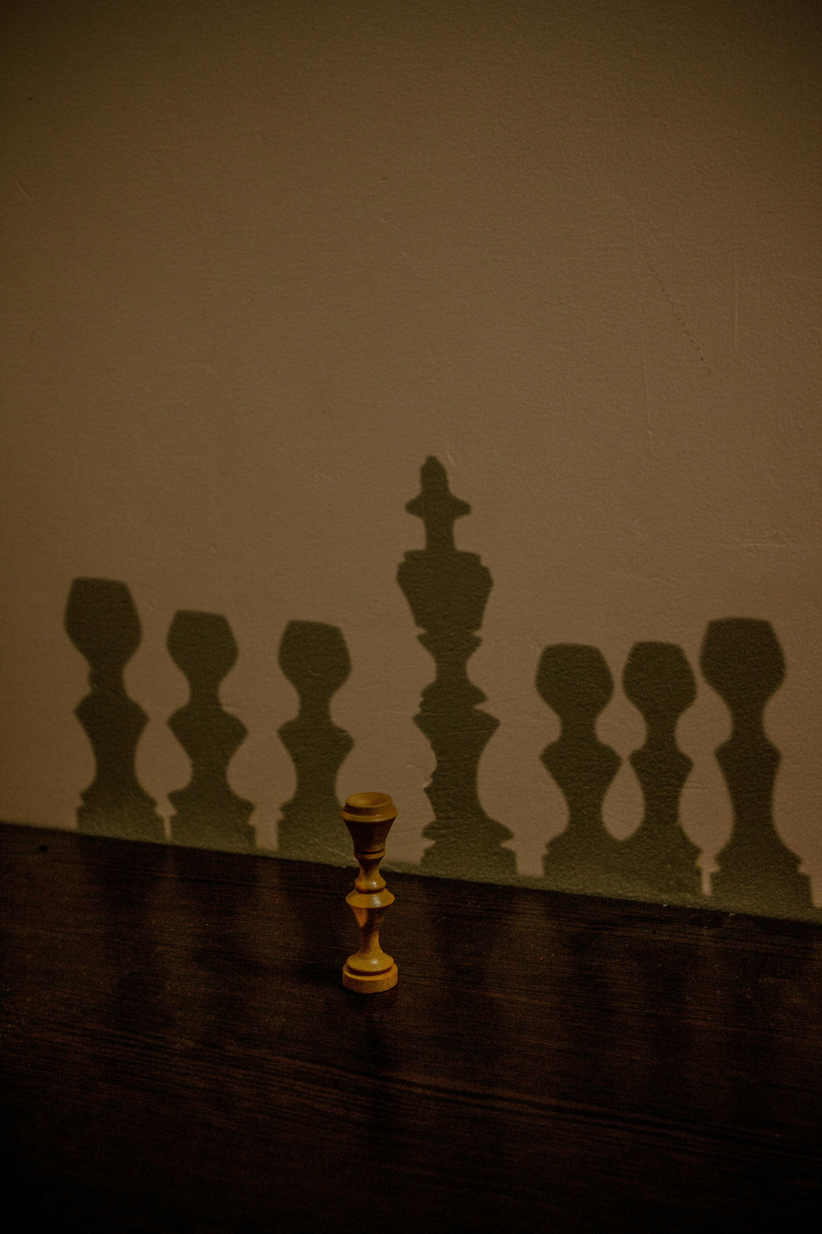Artistic Chess Shadows on Wooden Surface · Free Stock Photo