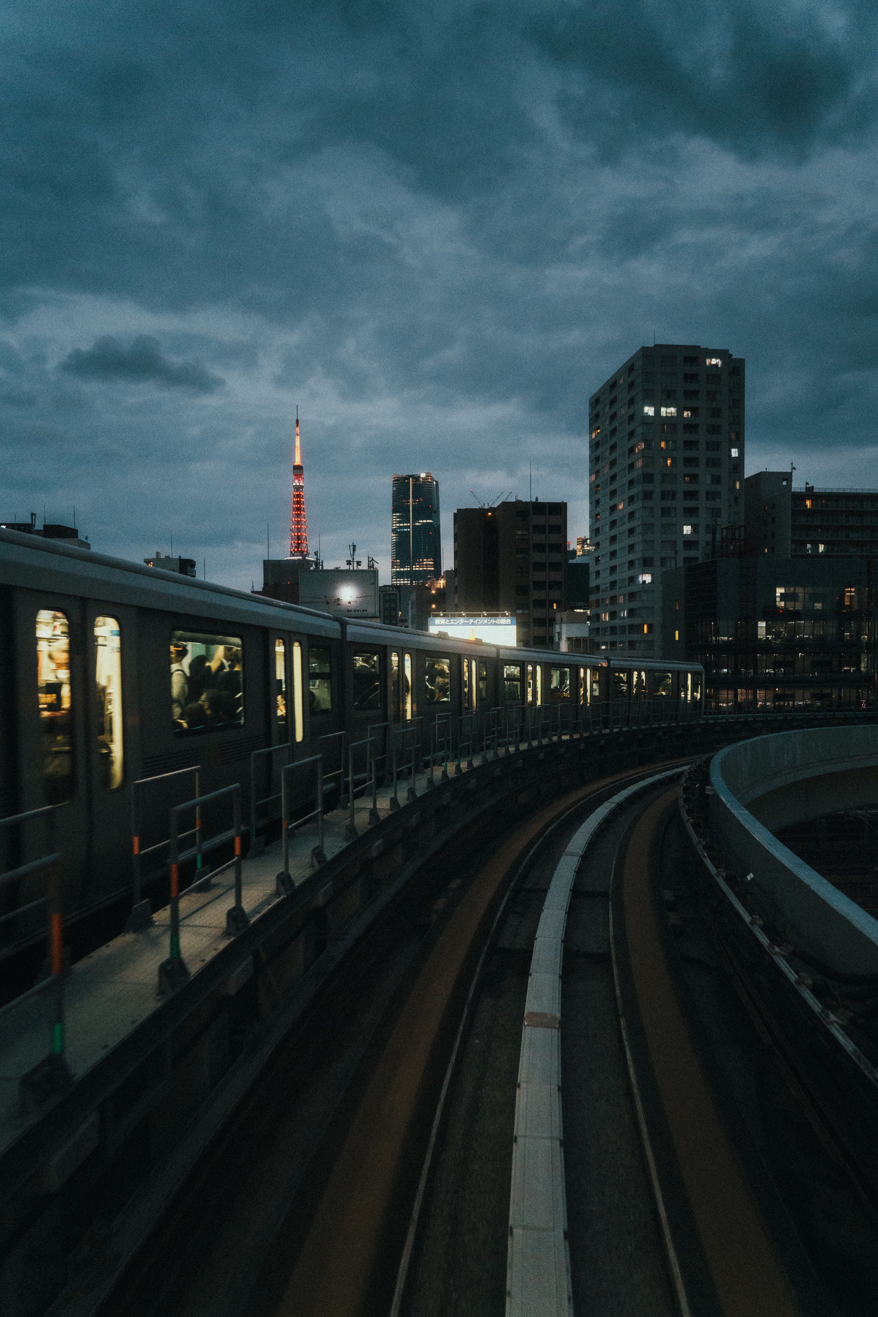Tokyo Night Train Passing Cityscape with Tower · Free Stock Photo