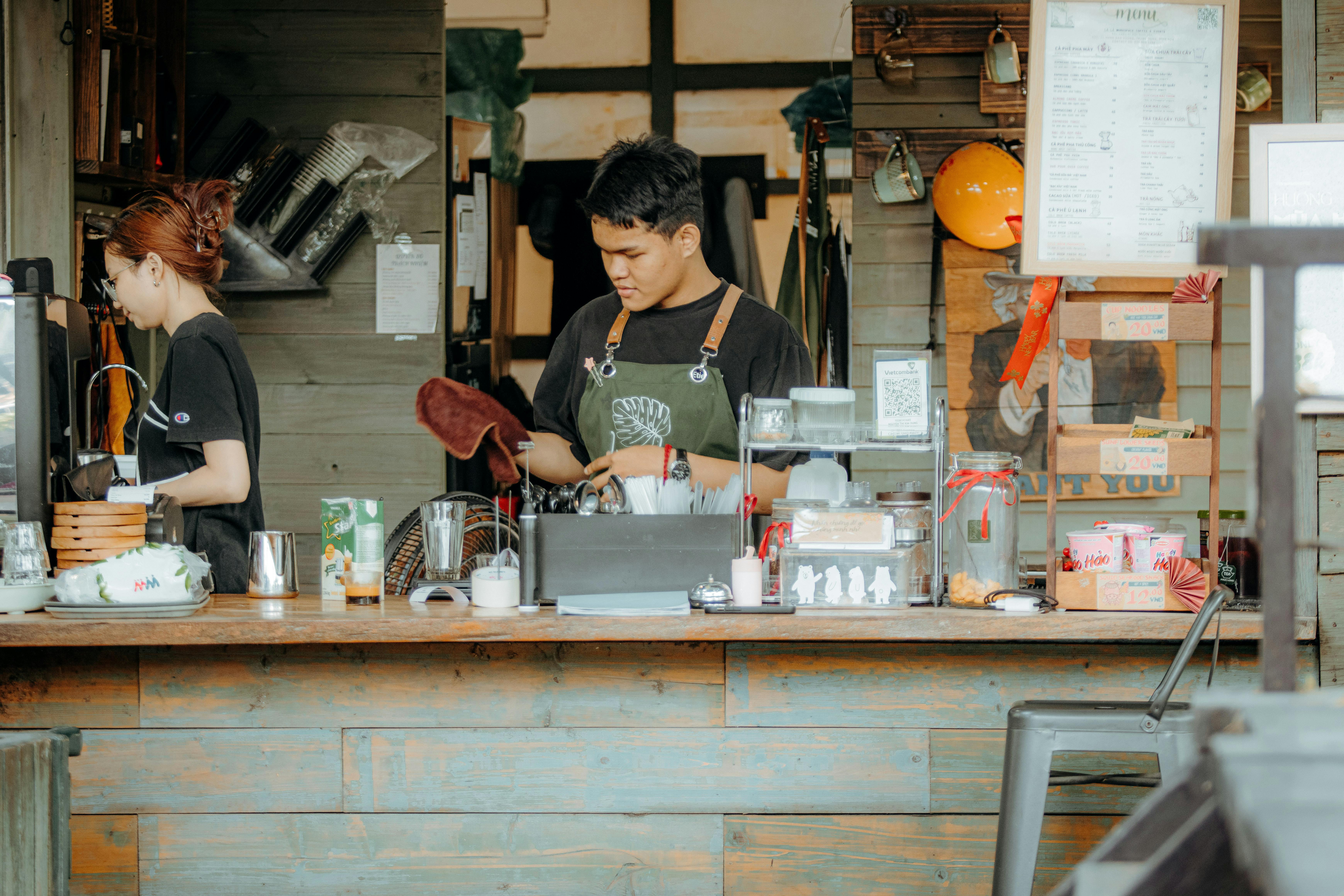 Coffee Shop Staff Preparing Drinks at Counter · Free Stock Photo