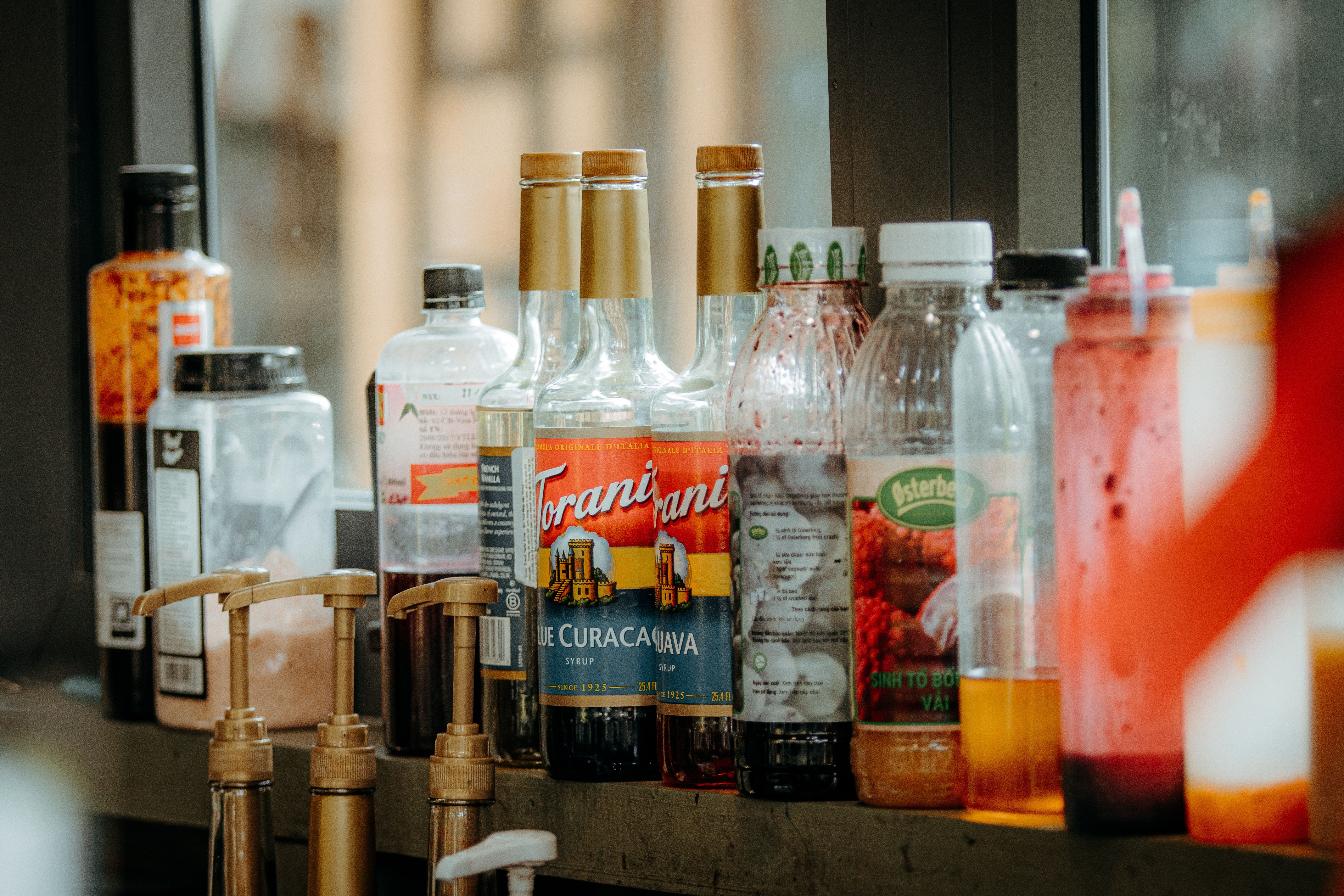 Assorted Bottles in a Café Setting · Free Stock Photo