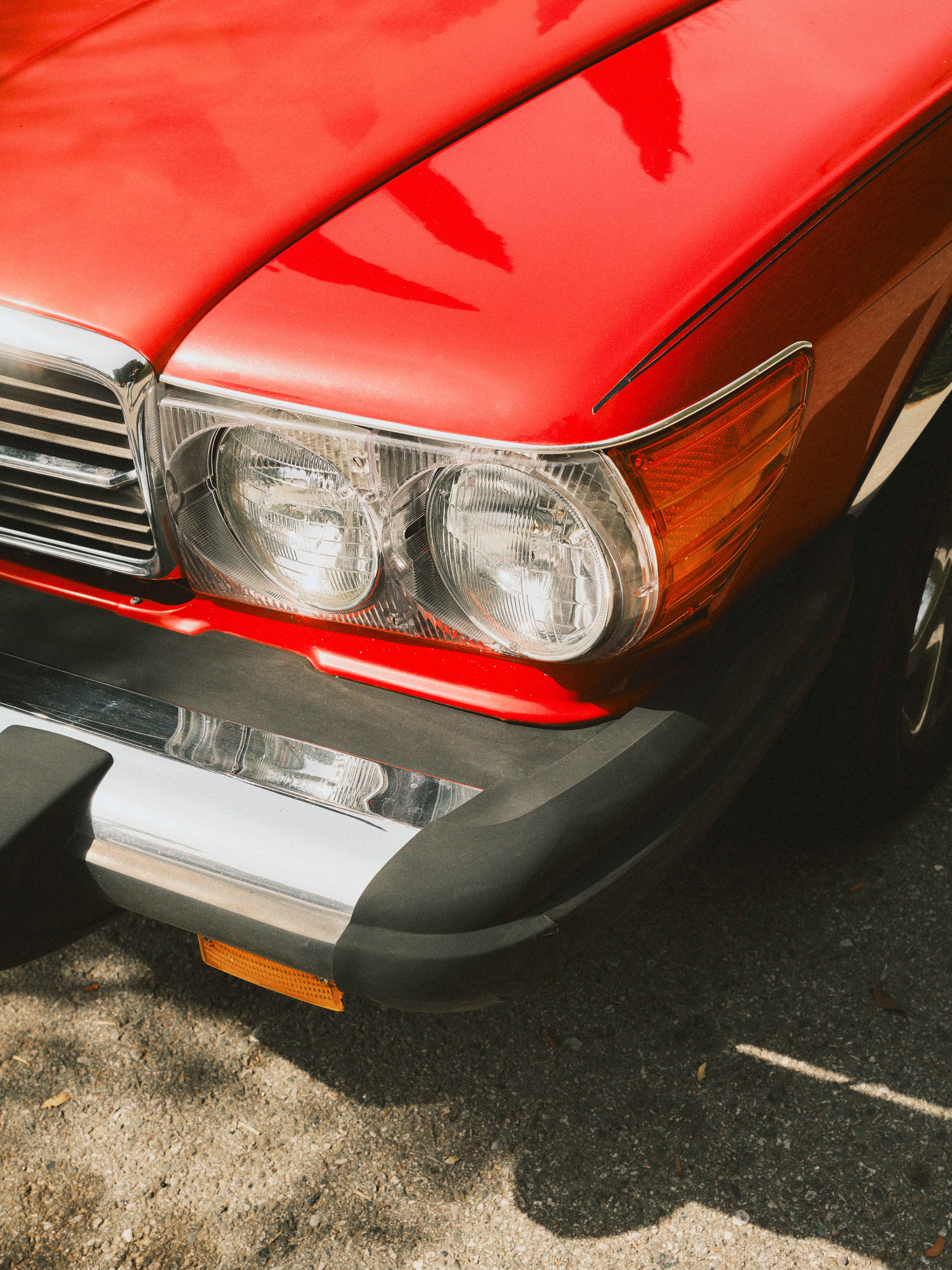 Vintage Red Car with Classic Headlight Design · Free Stock Photo