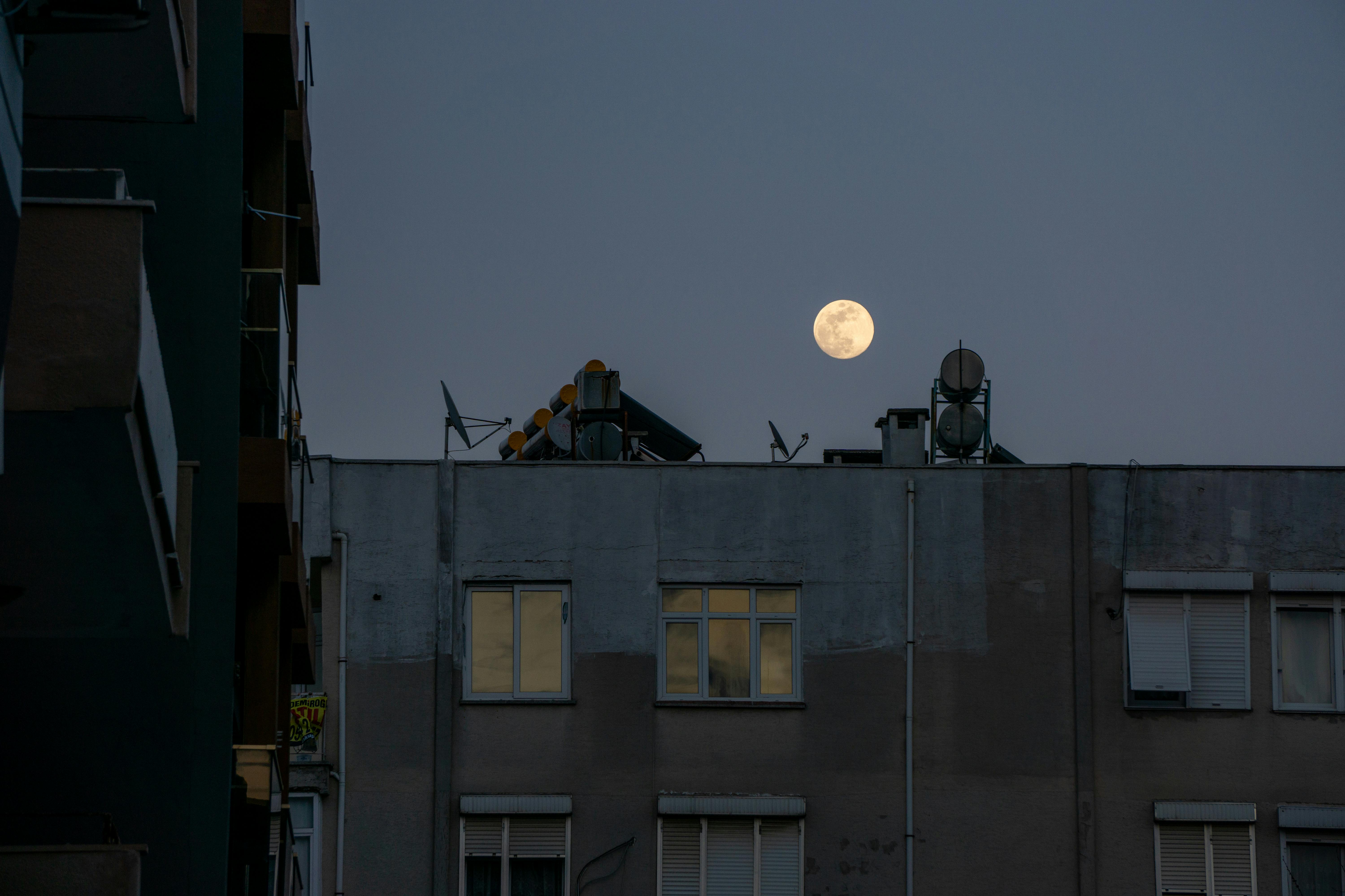 Full Moon Over Urban Rooftop Scene · Free Stock Photo