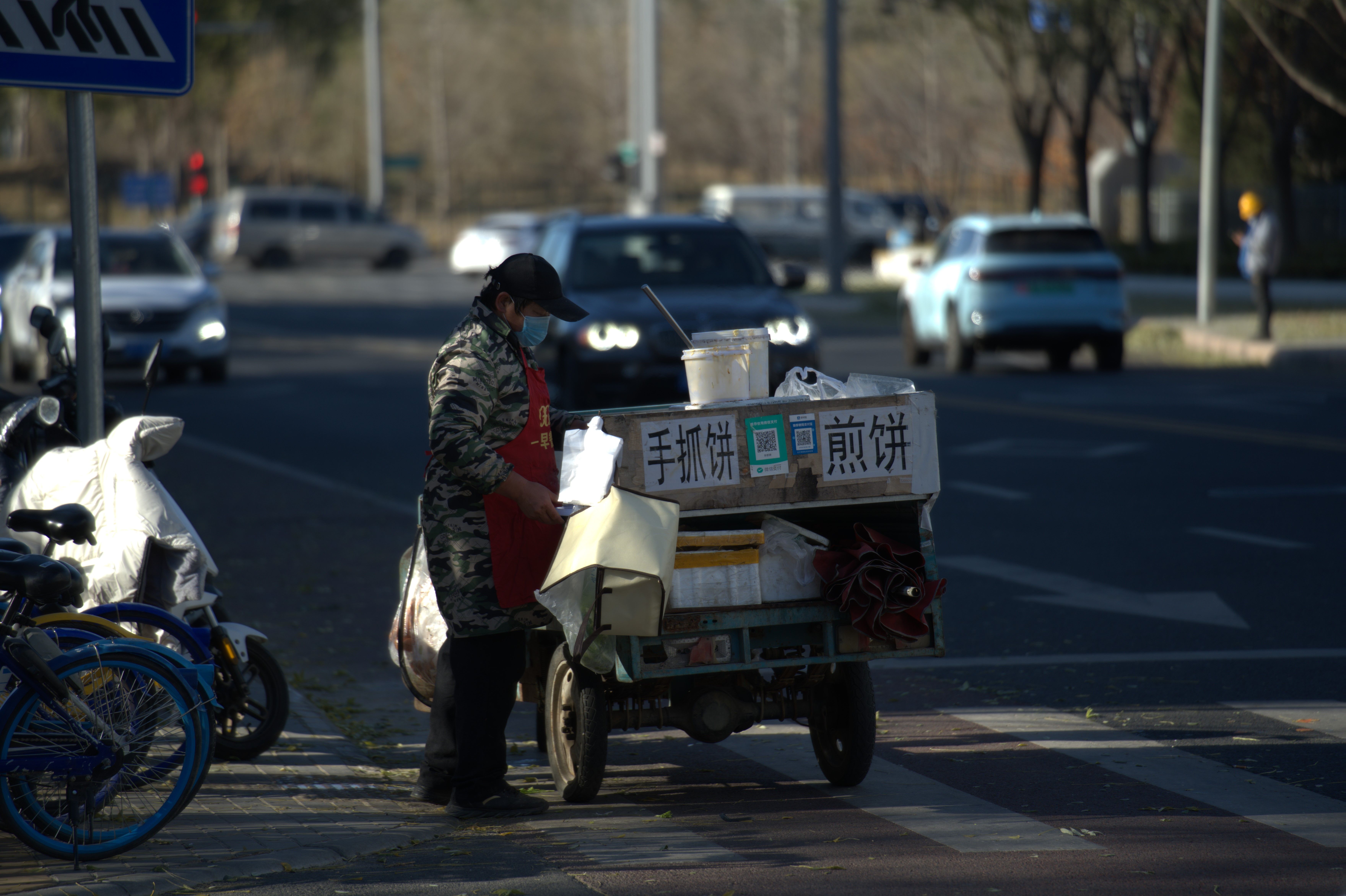 Street Vendor Selling Snacks in Urban Area · Free Stock Photo