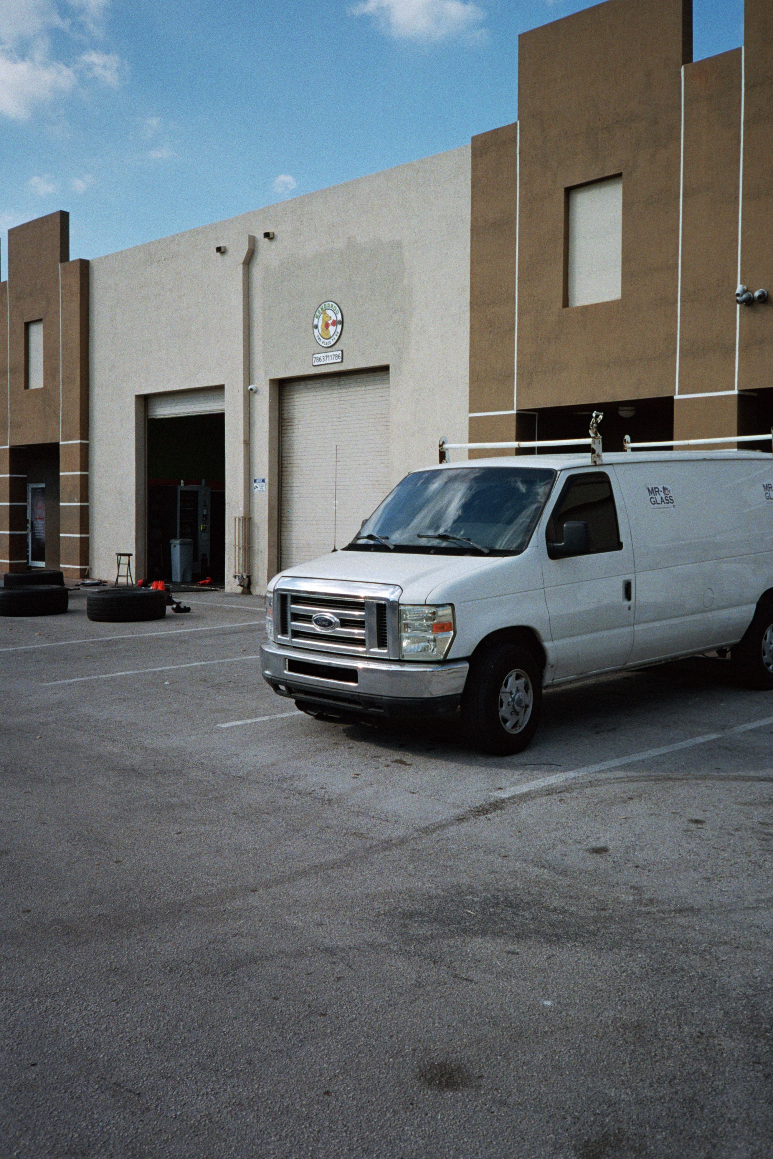 Commercial Van Parked outside Industrial Building · Free Stock Photo