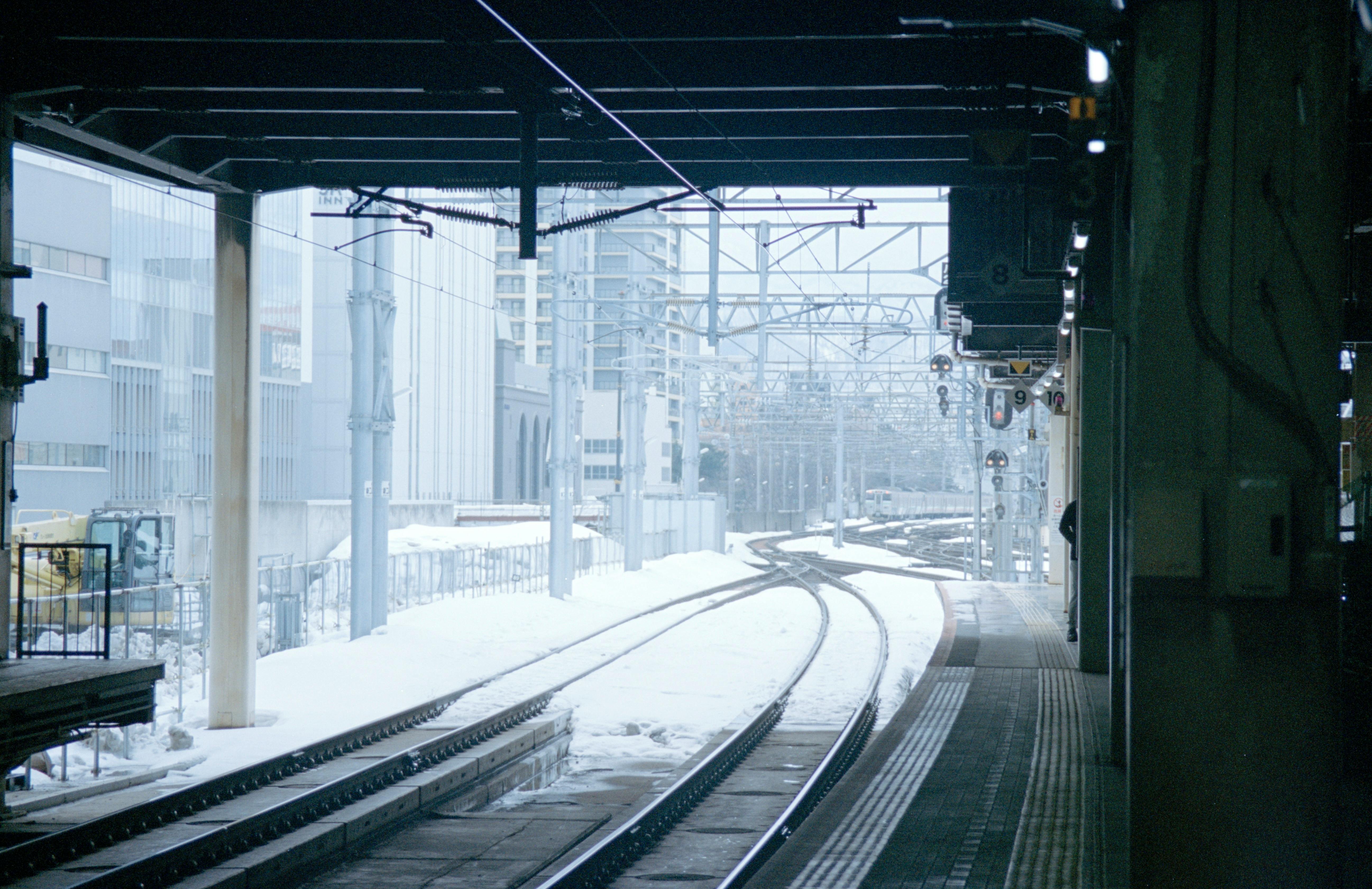 Snowy Urban Train Station with Tracks · Free Stock Photo