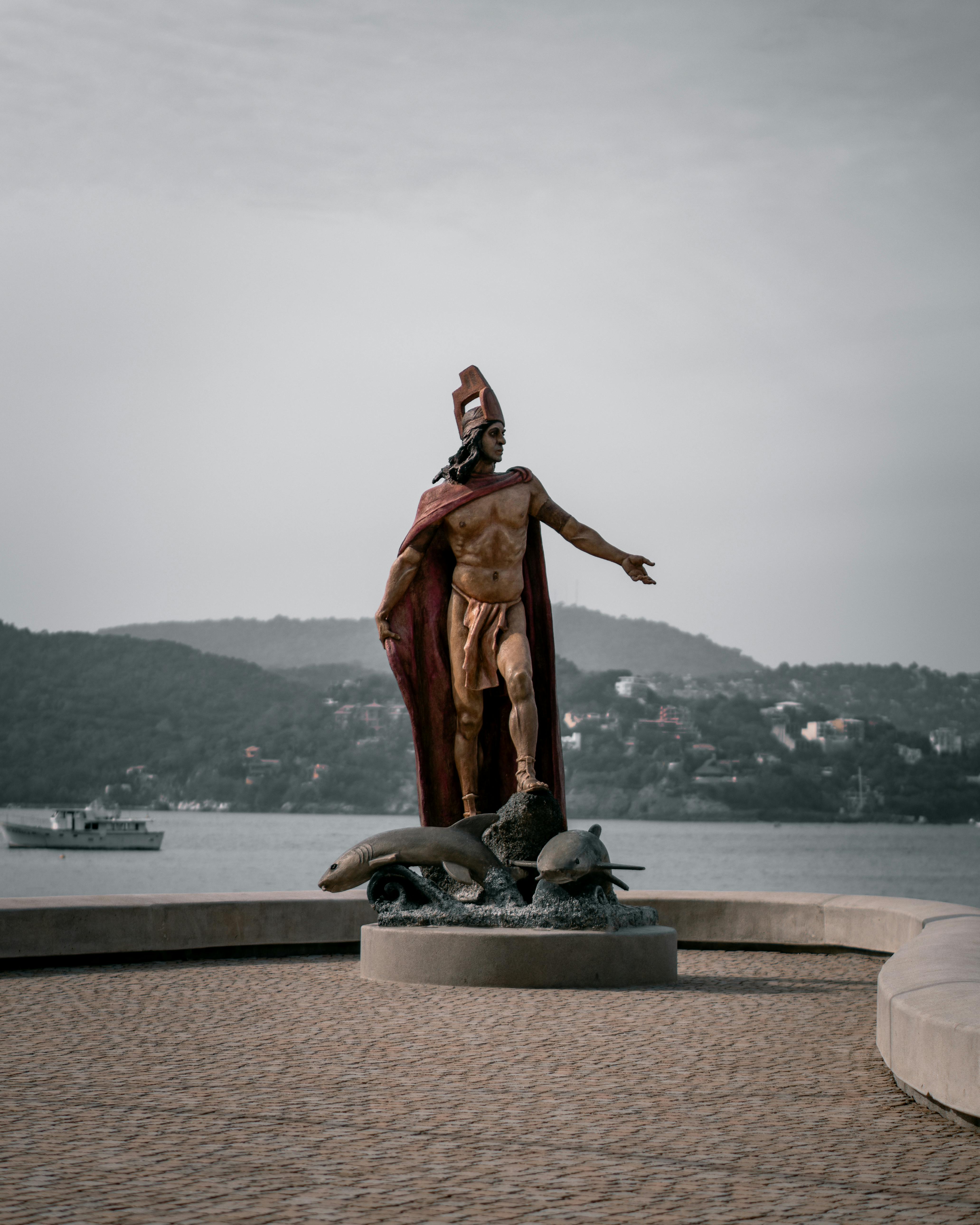 Impressive Statue by Lake Under Overcast Sky · Free Stock Photo