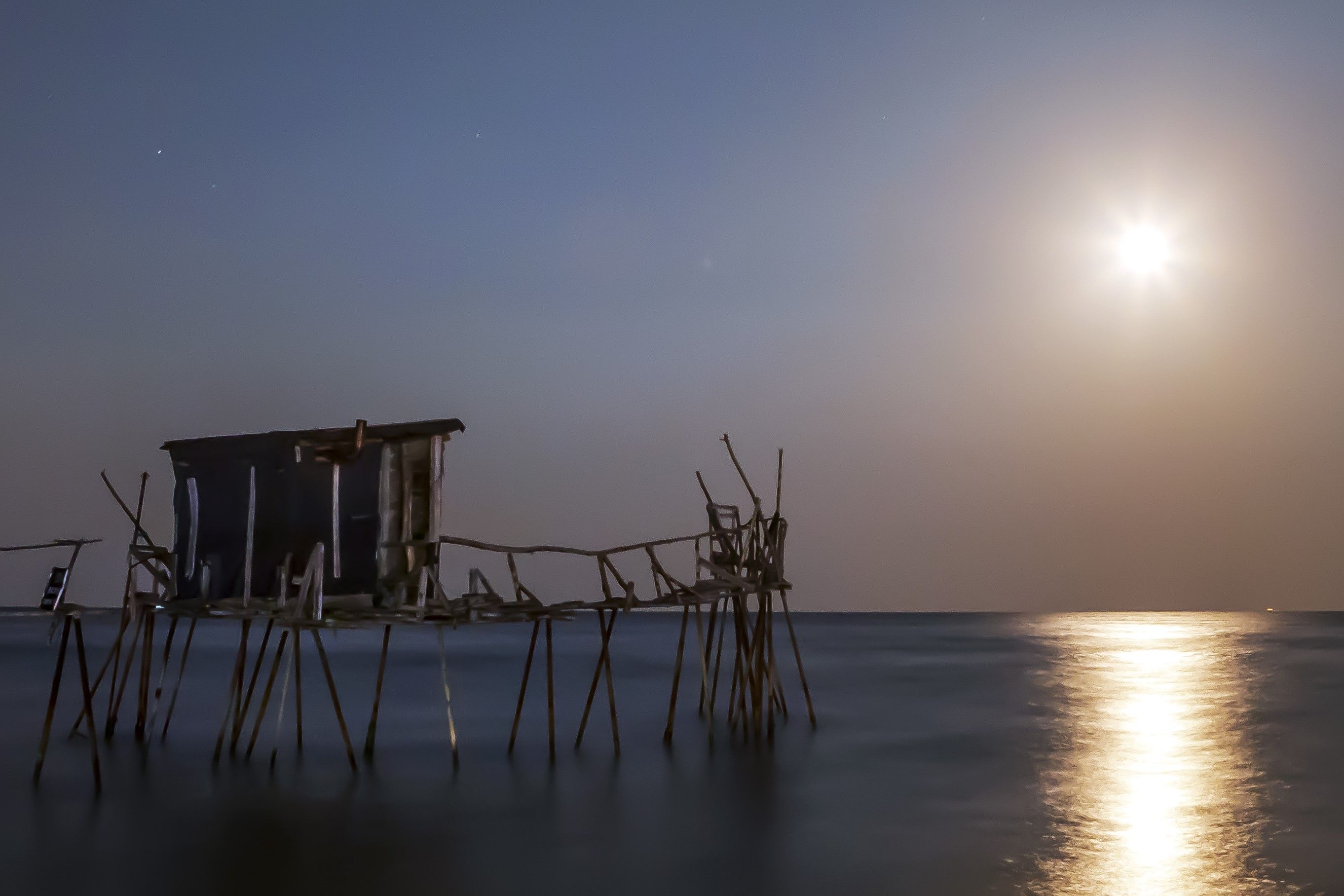 Moonlit Wooden Structure on Calm Water · Free Stock Photo