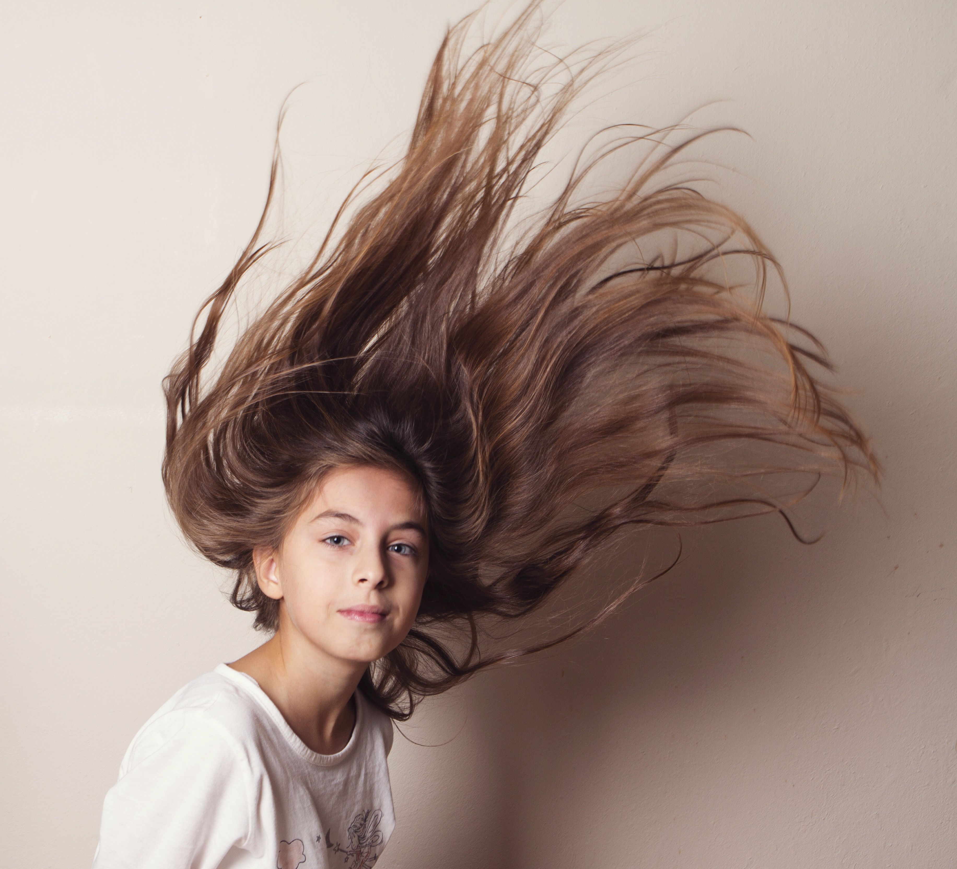 Young Girl with Flowing Hair Posing Indoors · Free Stock Photo
