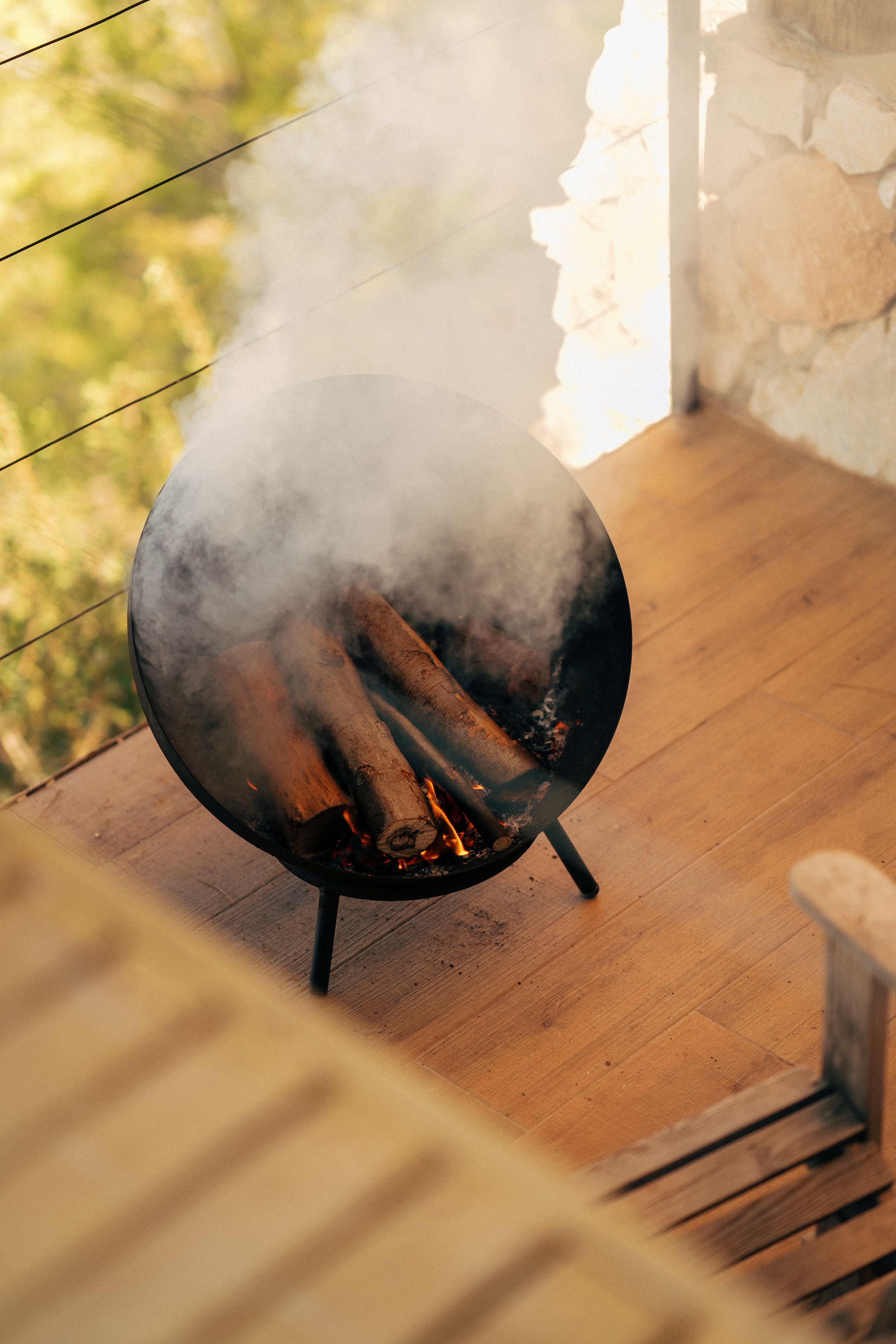Outdoor Fire Pit with Smoking Wood on Patio · Free Stock Photo