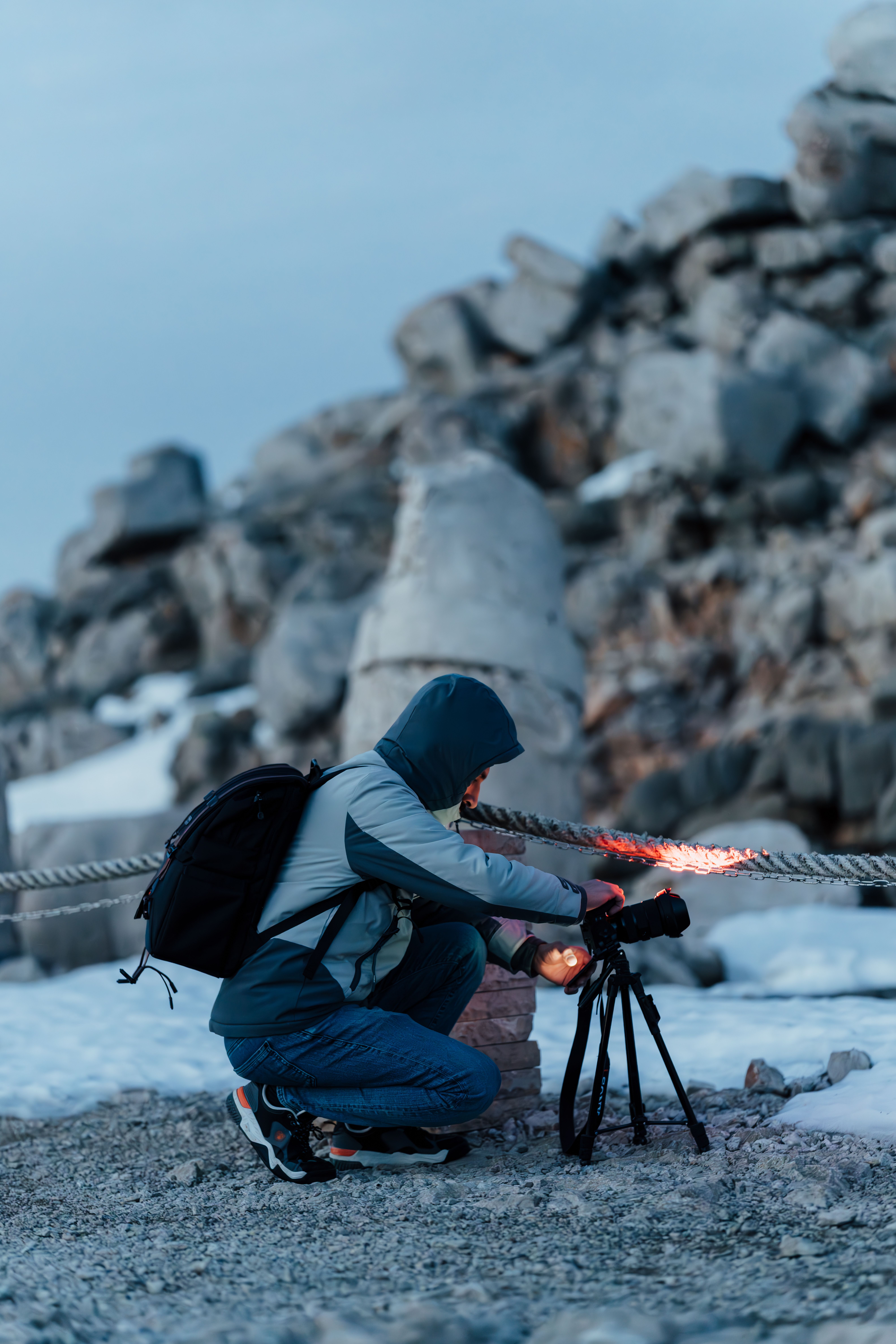 Photographer Setting Up Camera on Snowy Mountain · Free Stock Photo