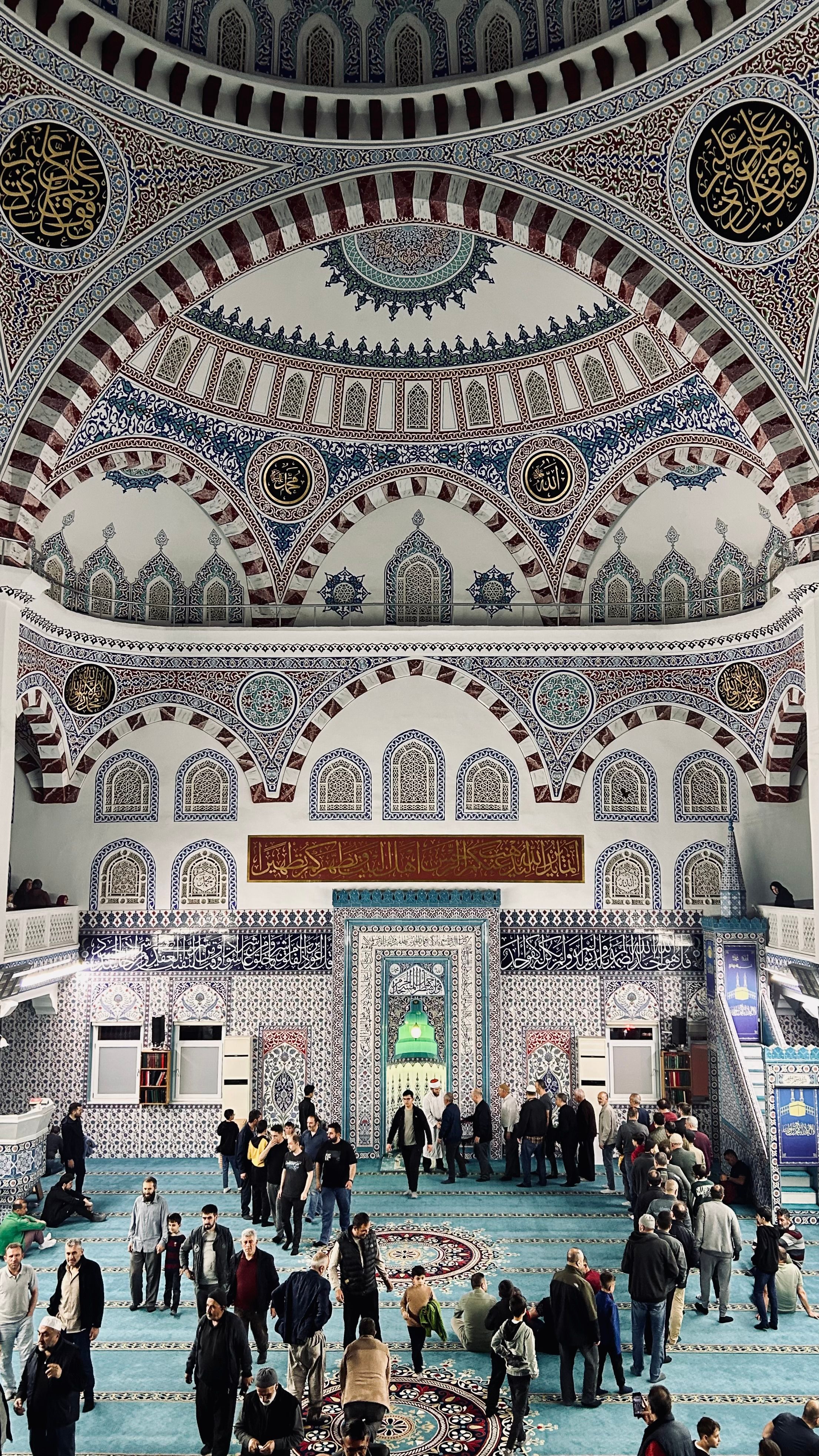 Vibrant Interior of Ornate Mosque with Visitors · Free Stock Photo