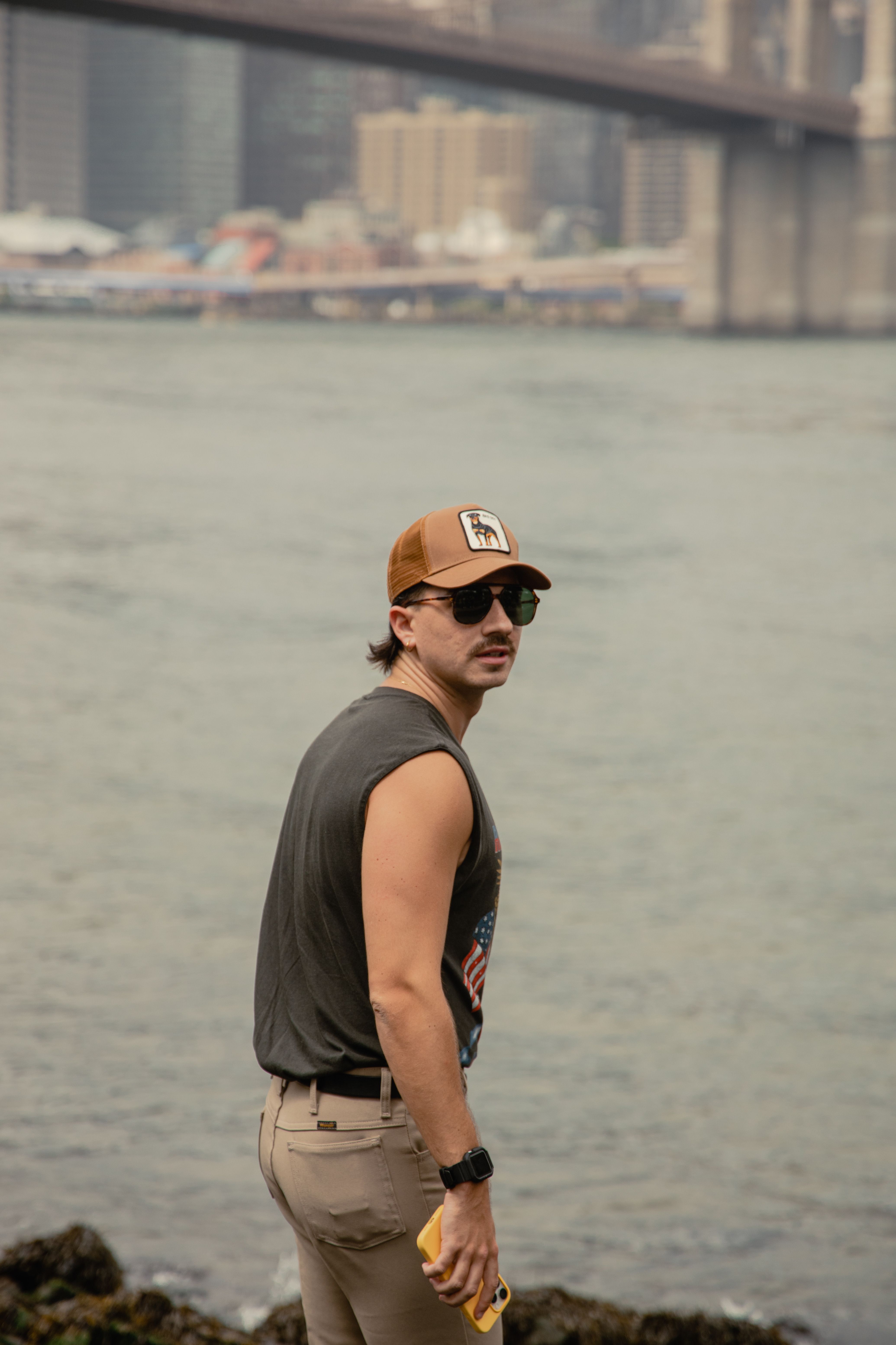 Adult Wearing Casual Outfit by a River with Bridge View · Free Stock Photo