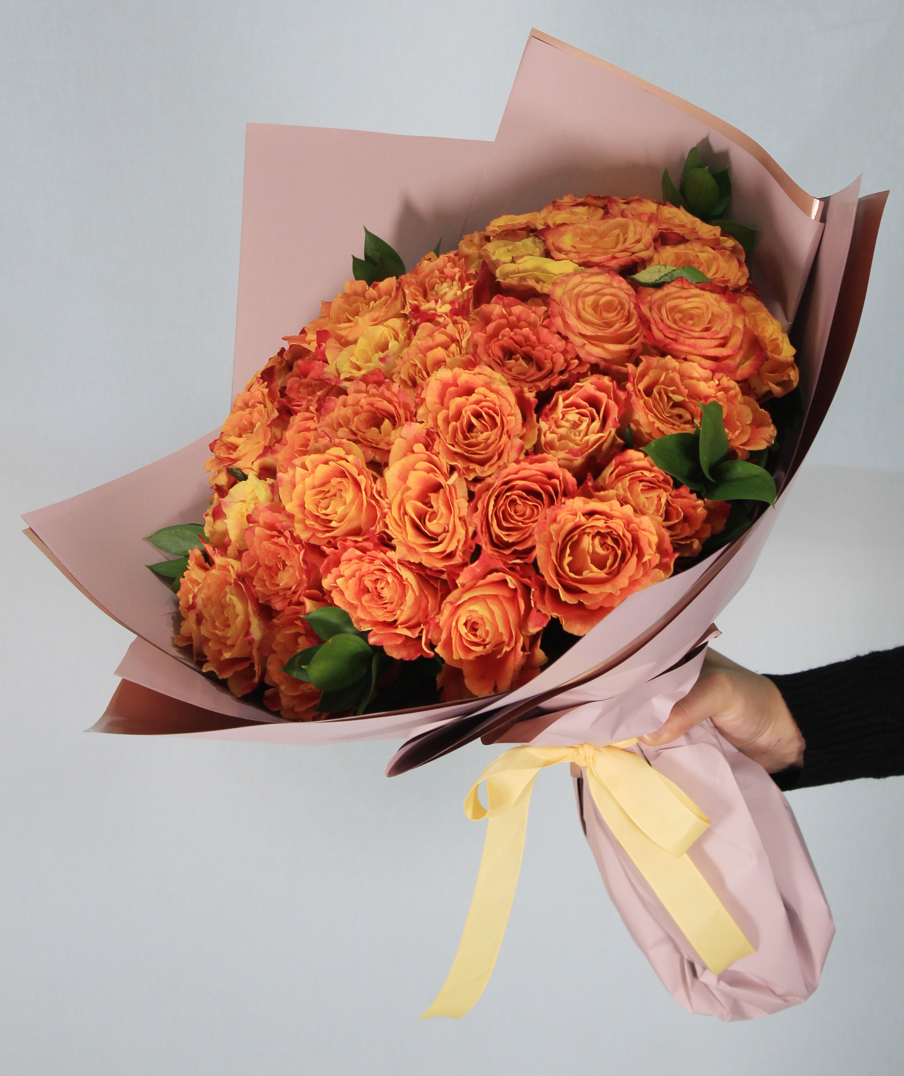 Vibrant Orange Rose Bouquet with Elegant Wrap · Free Stock Photo