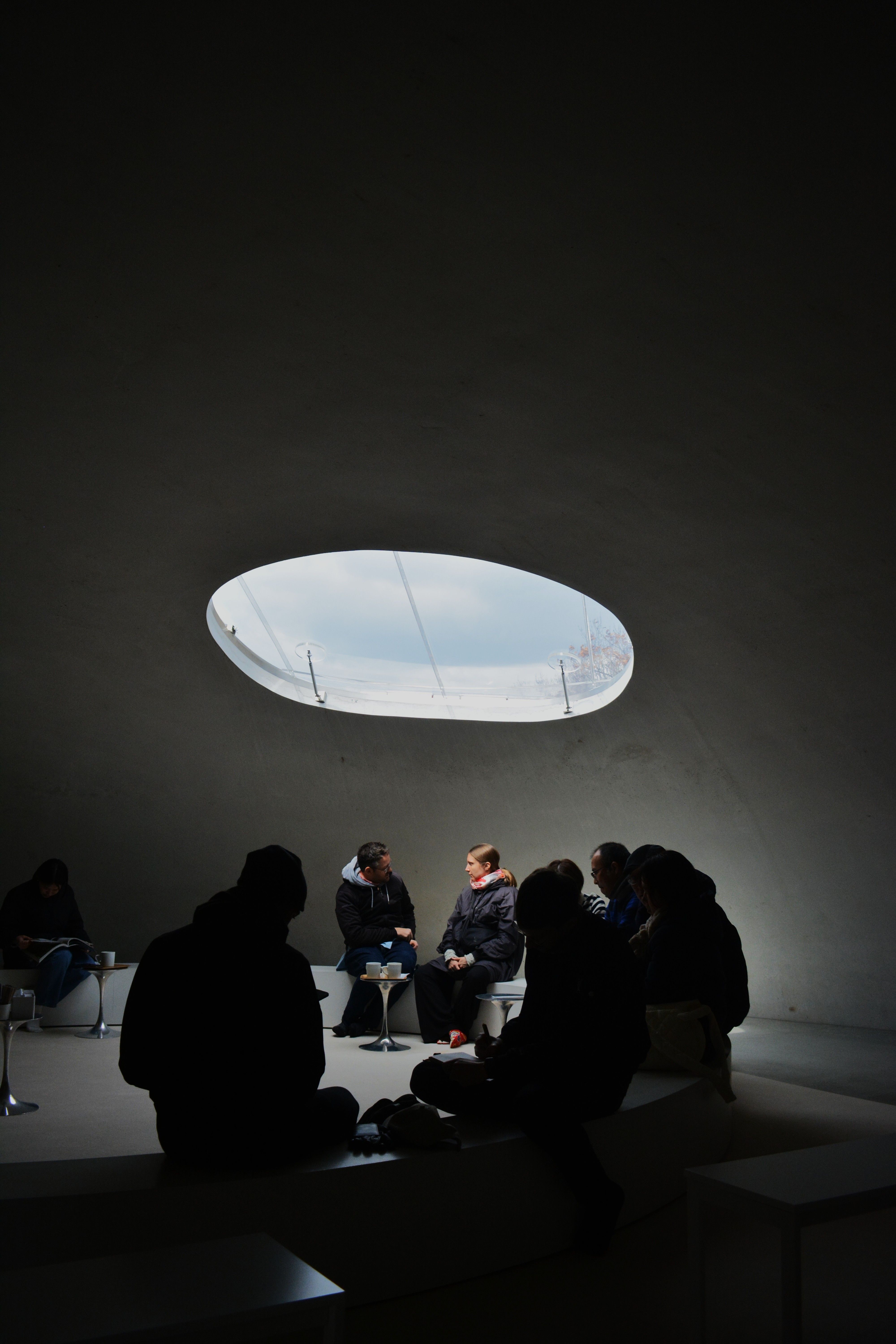 Silhouetted Group Under Skylight in Modern Space · Free Stock Photo