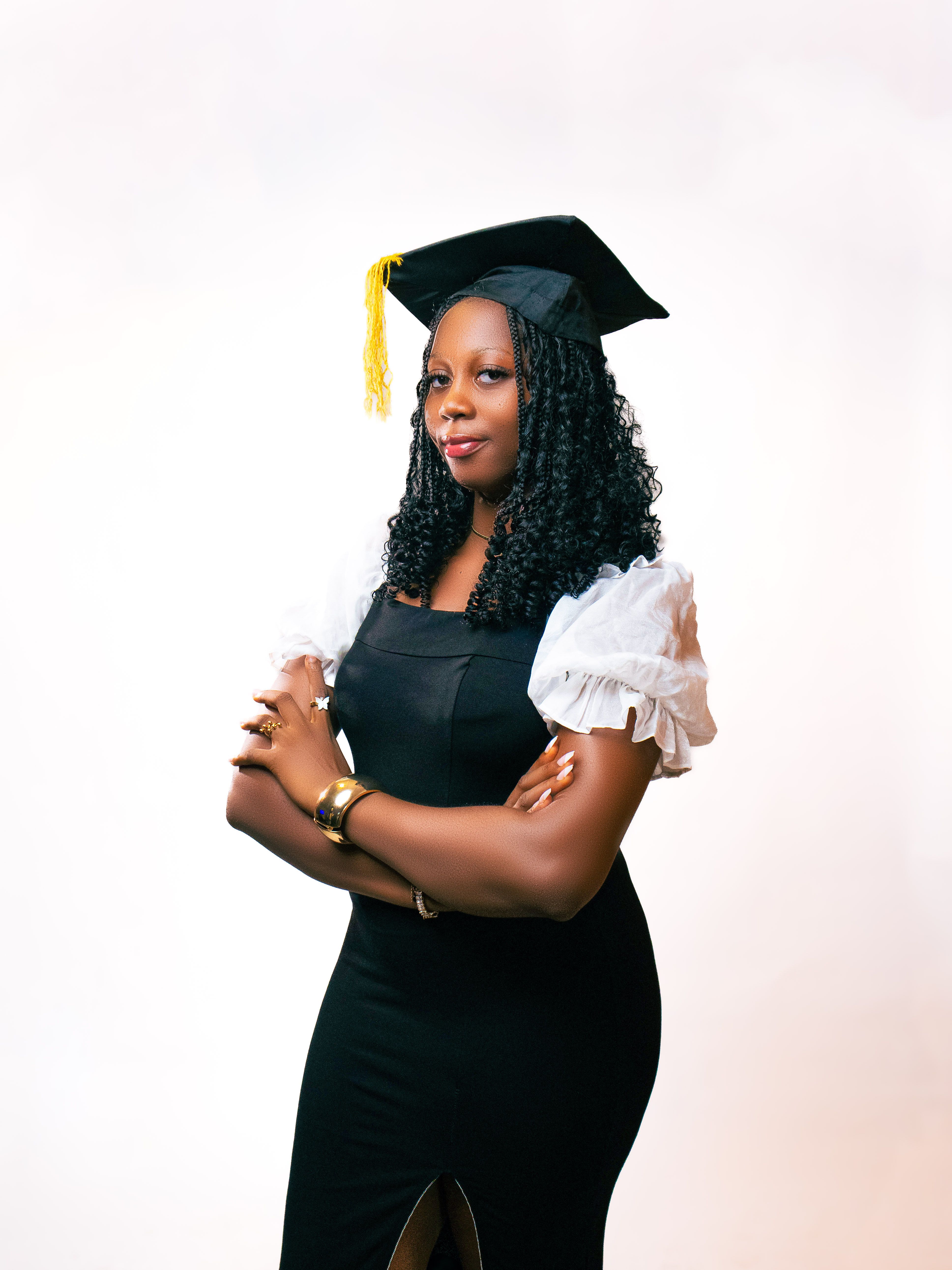 Confident Graduate Posing in Cap and Gown · Free Stock Photo