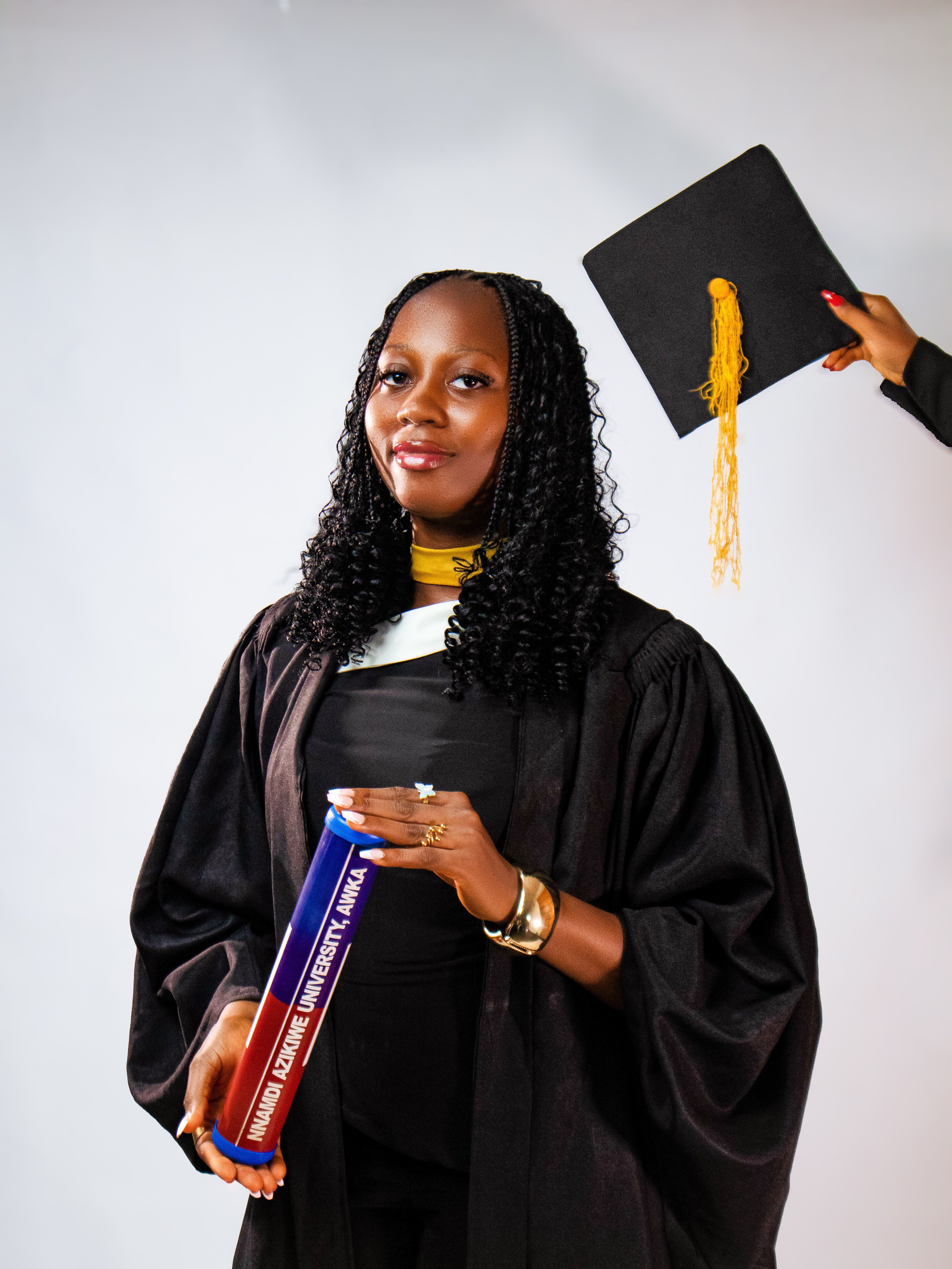 Elegant Graduation Ceremony Portrait with Diploma · Free Stock Photo