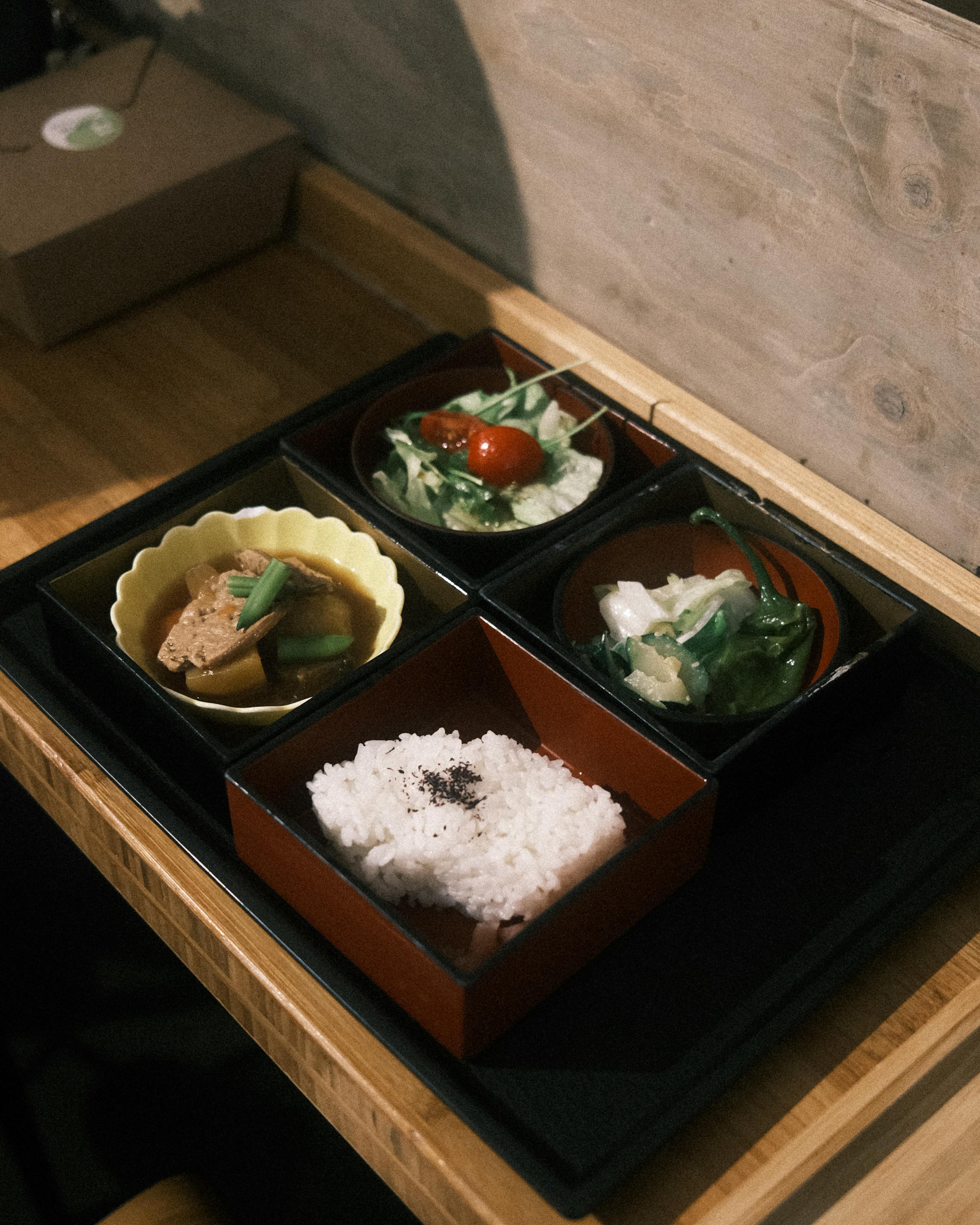 Traditional Japanese Bento Box on Wooden Table · Free Stock Photo