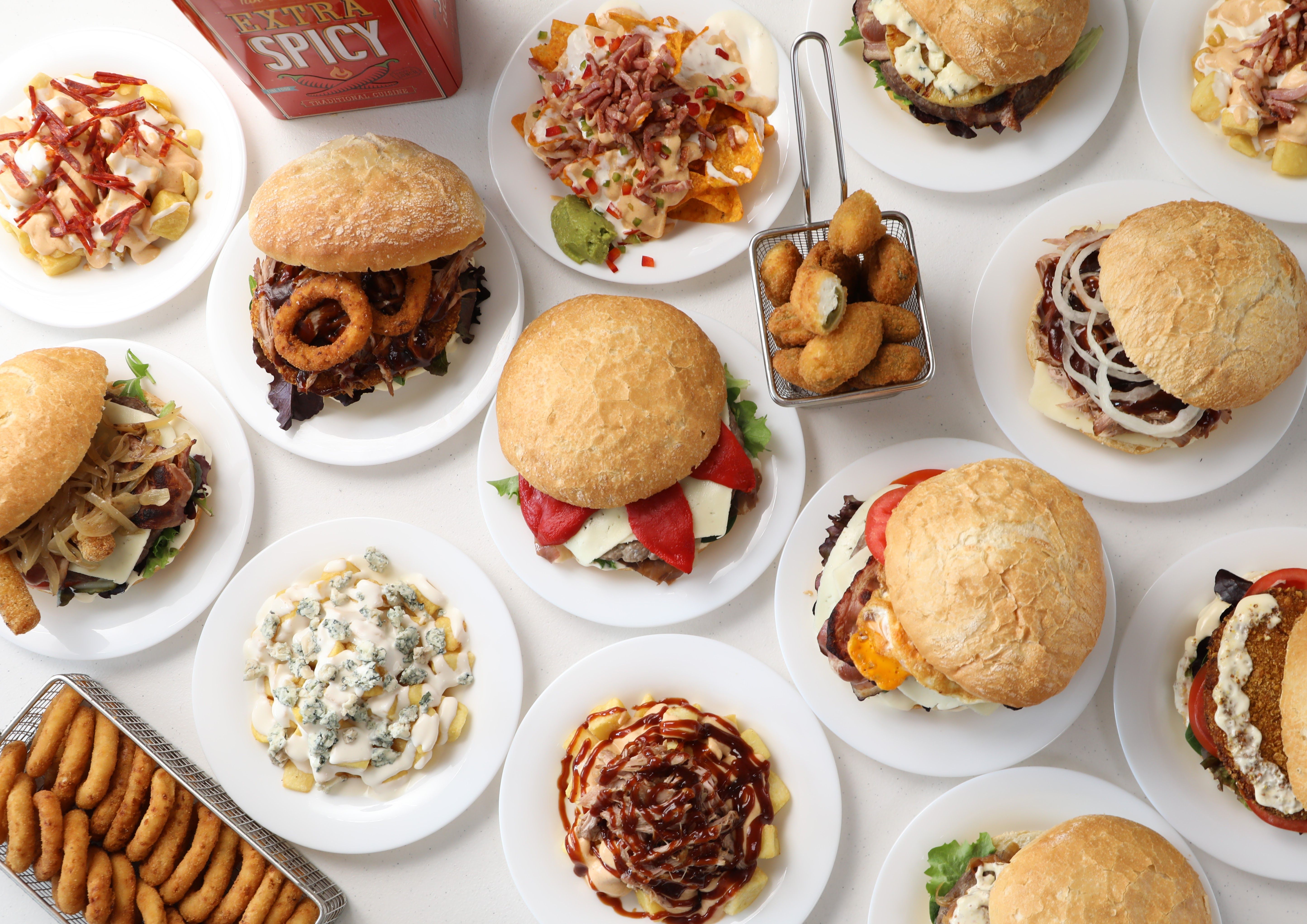 Variety of Gourmet Burgers and Sides on Display · Free Stock Photo