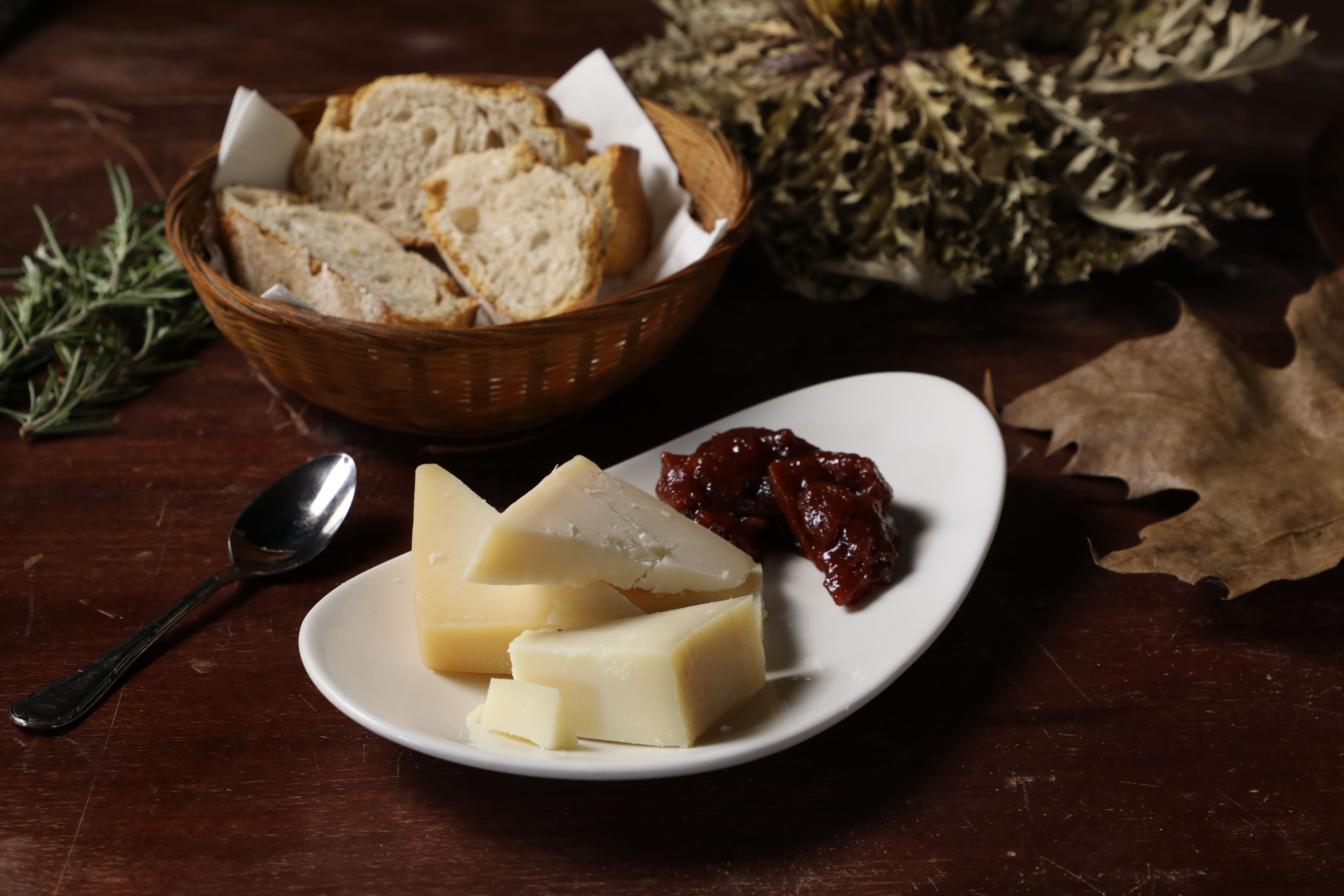Gourmet Cheese and Bread Plate on Rustic Table · Free Stock Photo