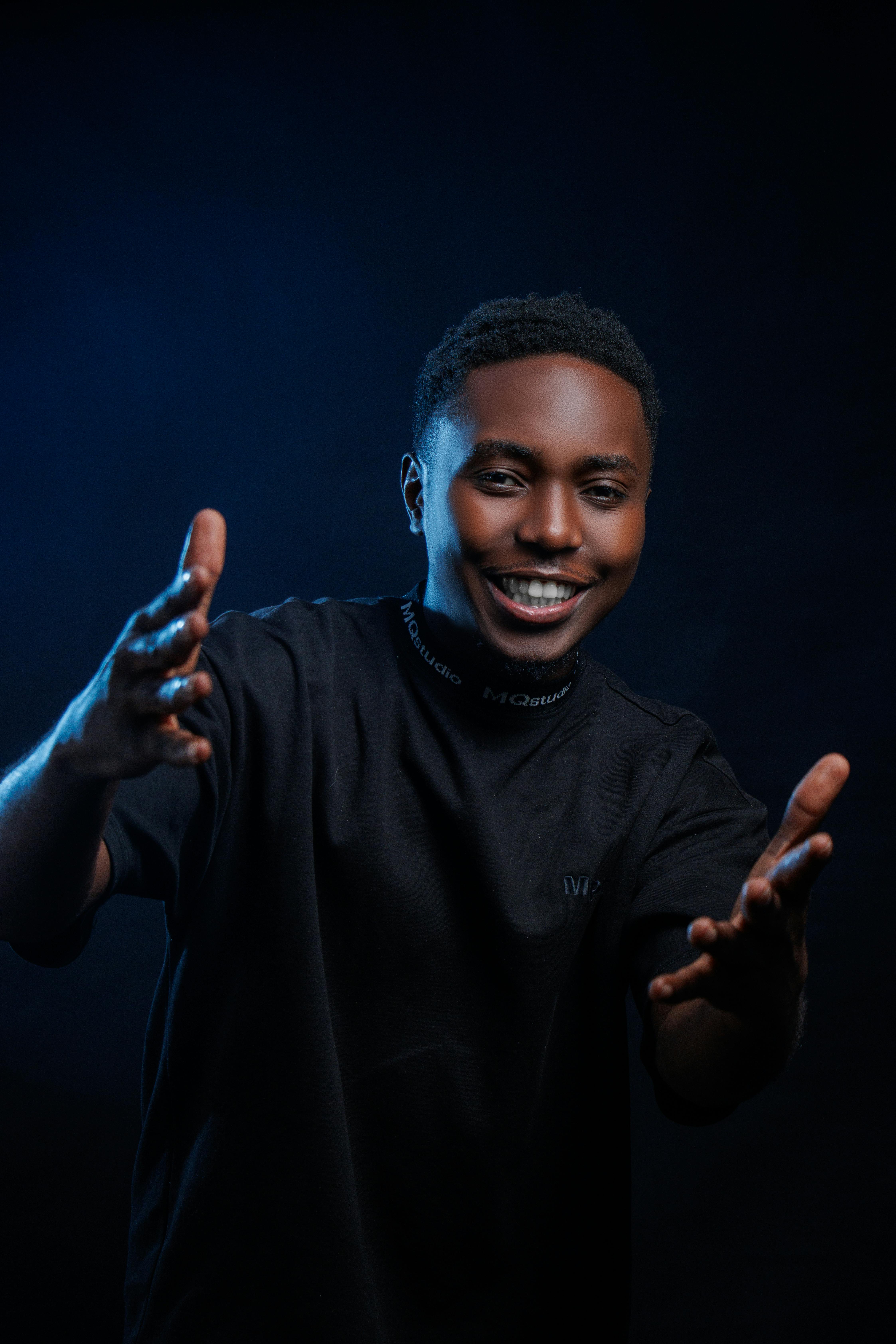 Dynamic Portrait of Smiling Young Man in Black · Free Stock Photo