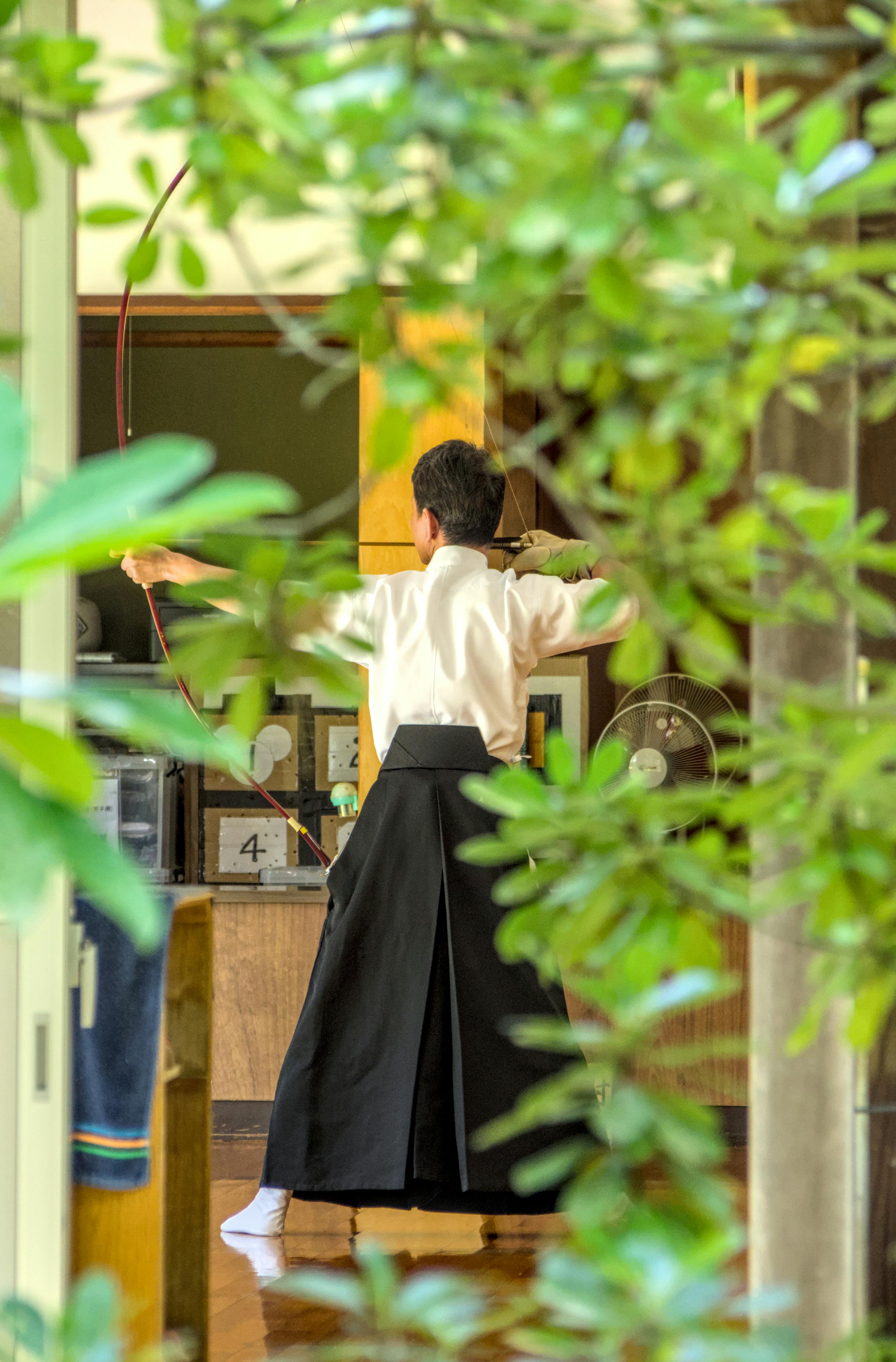 Traditional Japanese Archer Practicing Indoors · Free Stock Photo