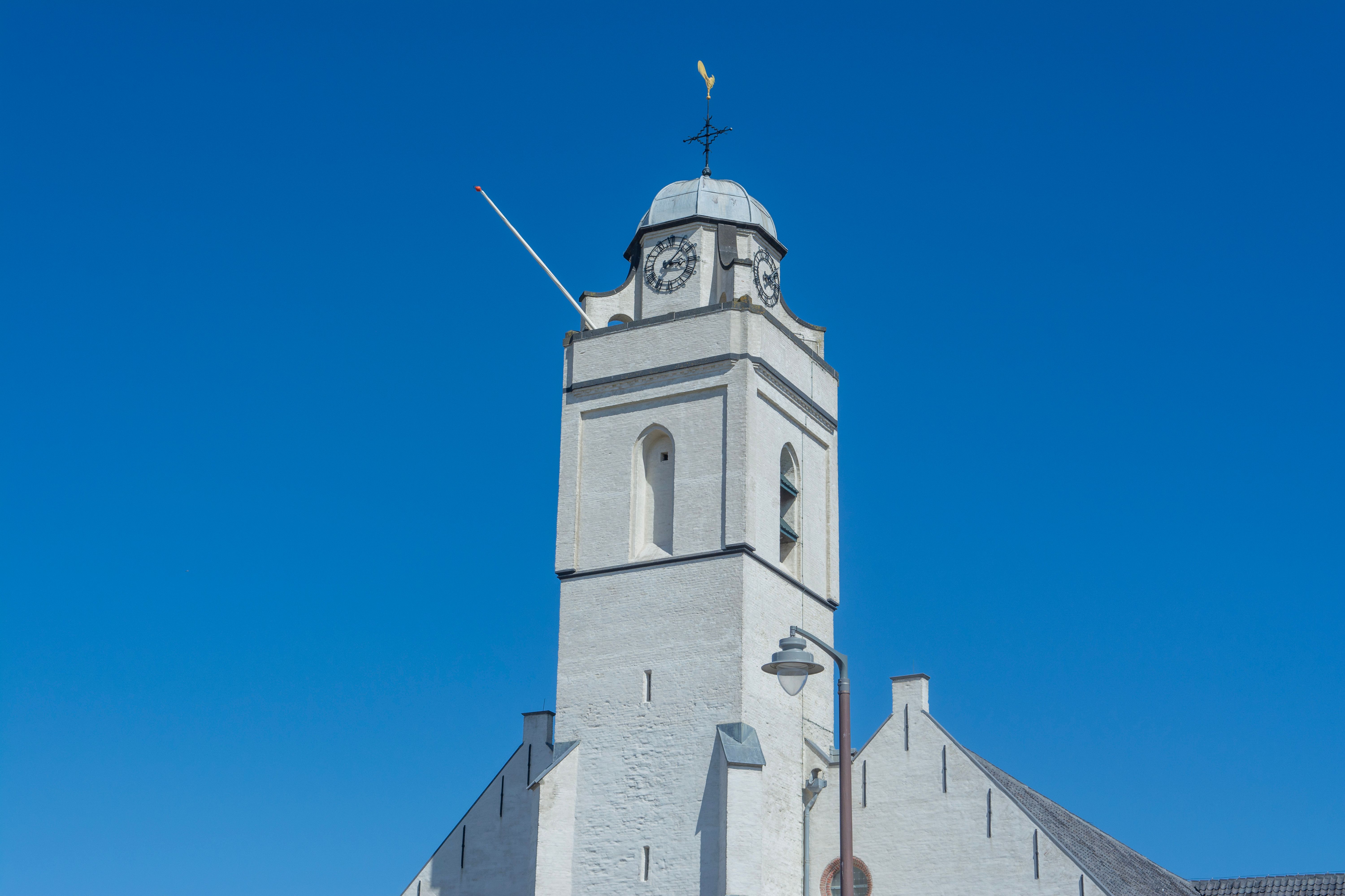 White Church Tower Against Blue Sky in Katwijk · Free Stock Photo