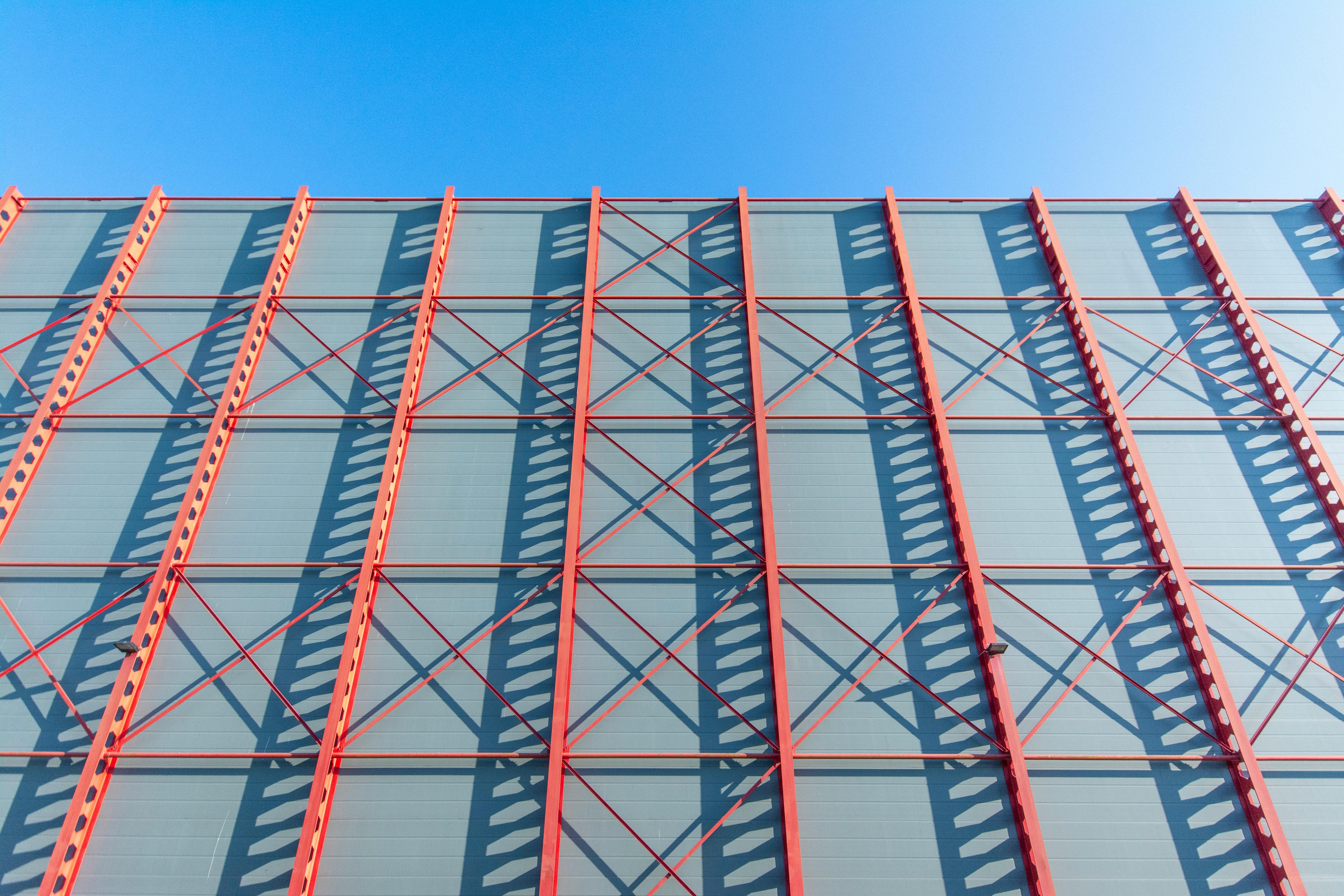Modern Building Facade with Red Metal Beams · Free Stock Photo