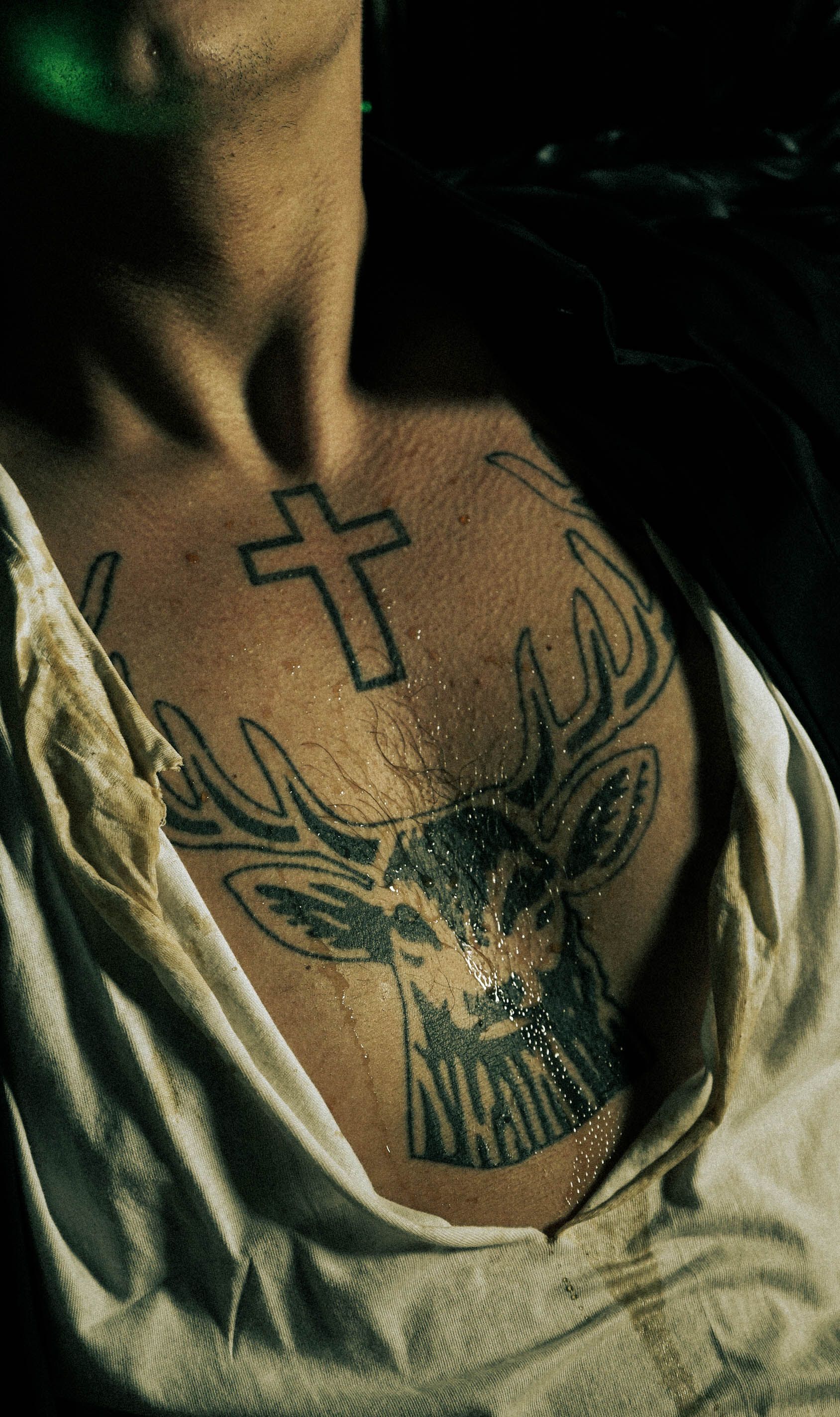 Close-up of Chest Tattoo Featuring a Deer and Cross · Free Stock Photo