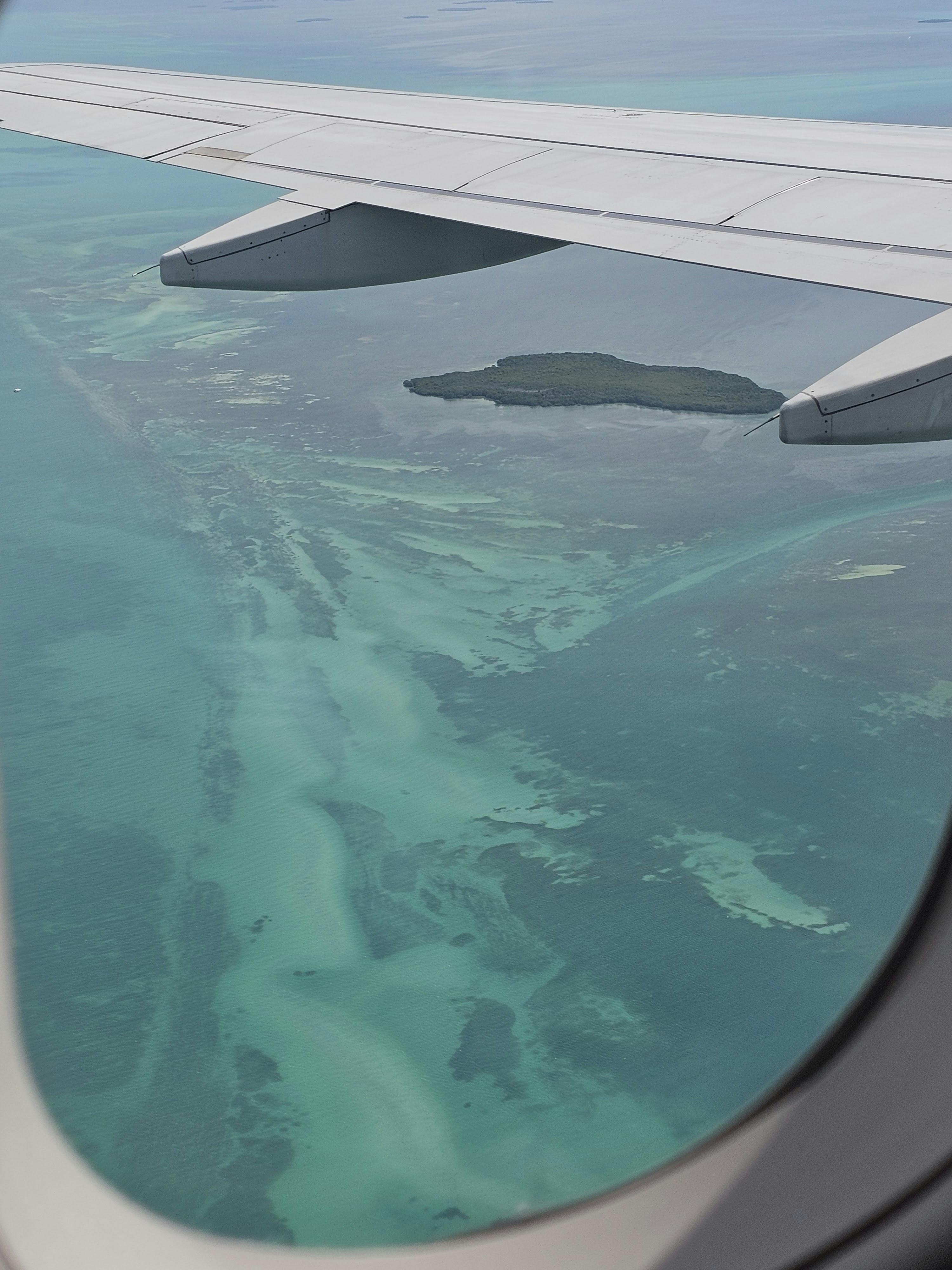 Aerial View of Tropical Island from Plane Window · Free Stock Photo