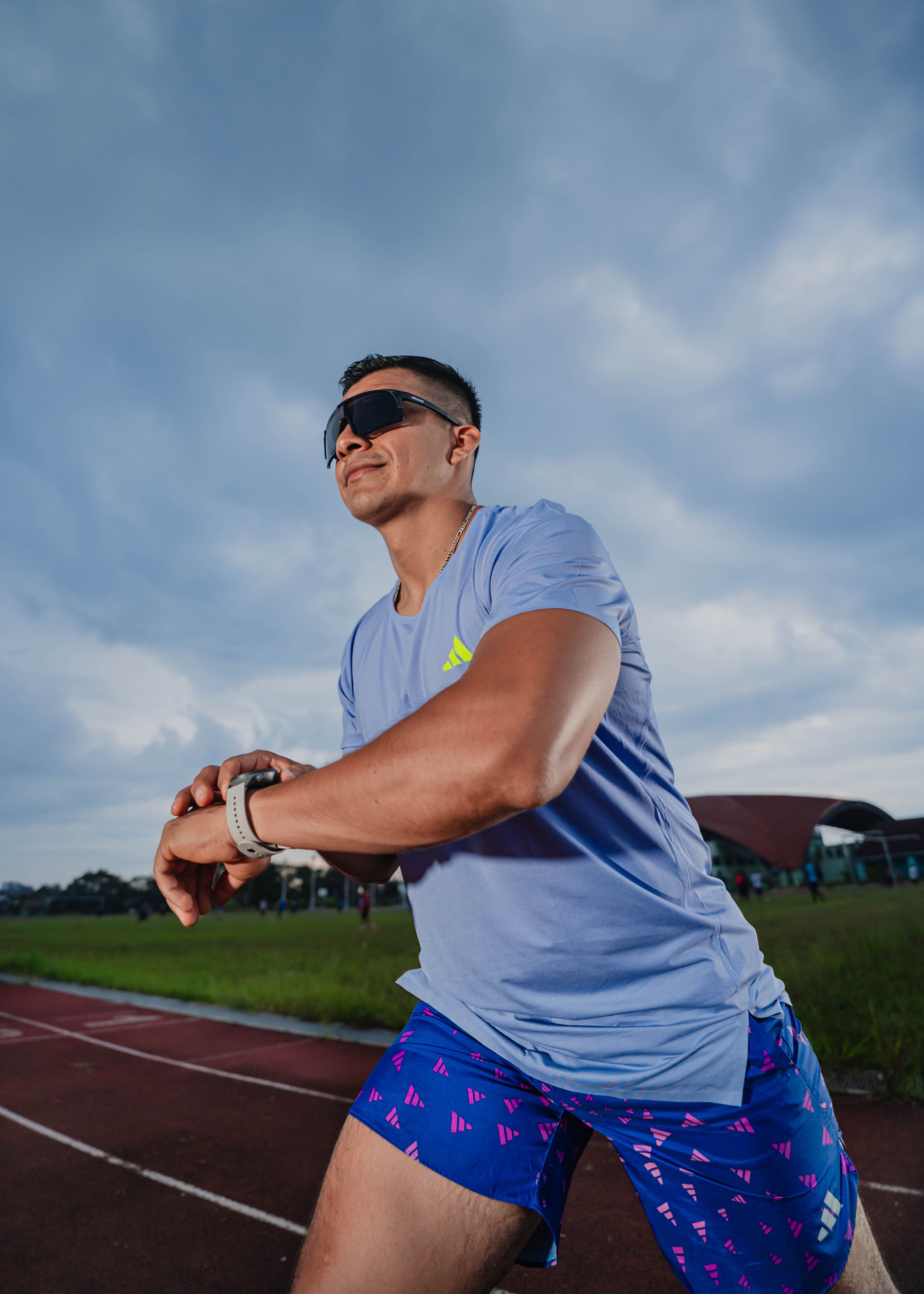 Runner Preparing for Race on Outdoor Track · Free Stock Photo