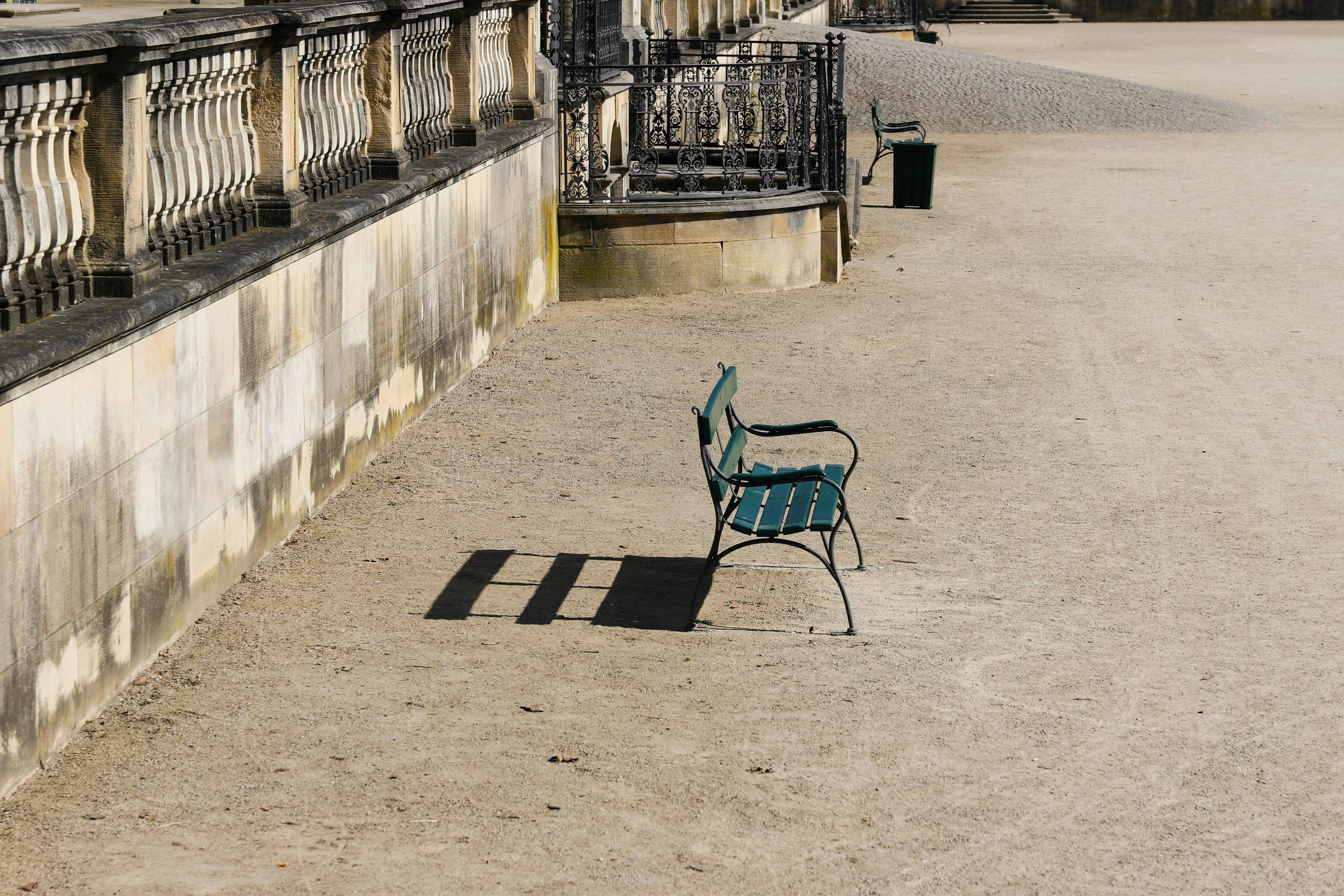 Elegant Bench and Shadows in Sunlit Park · Free Stock Photo