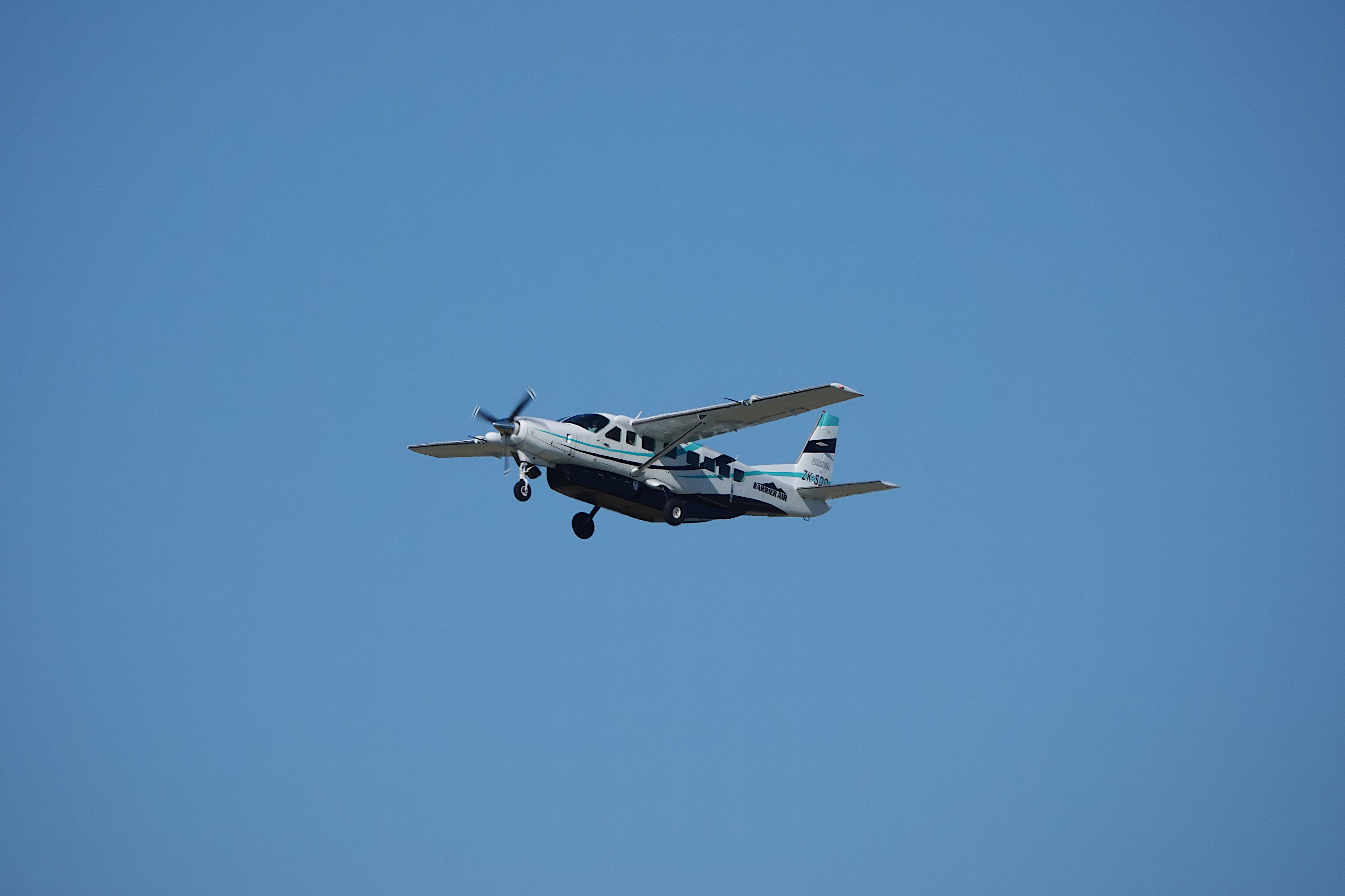 Small Airplane Flying Over New Zealand Skies · Free Stock Photo