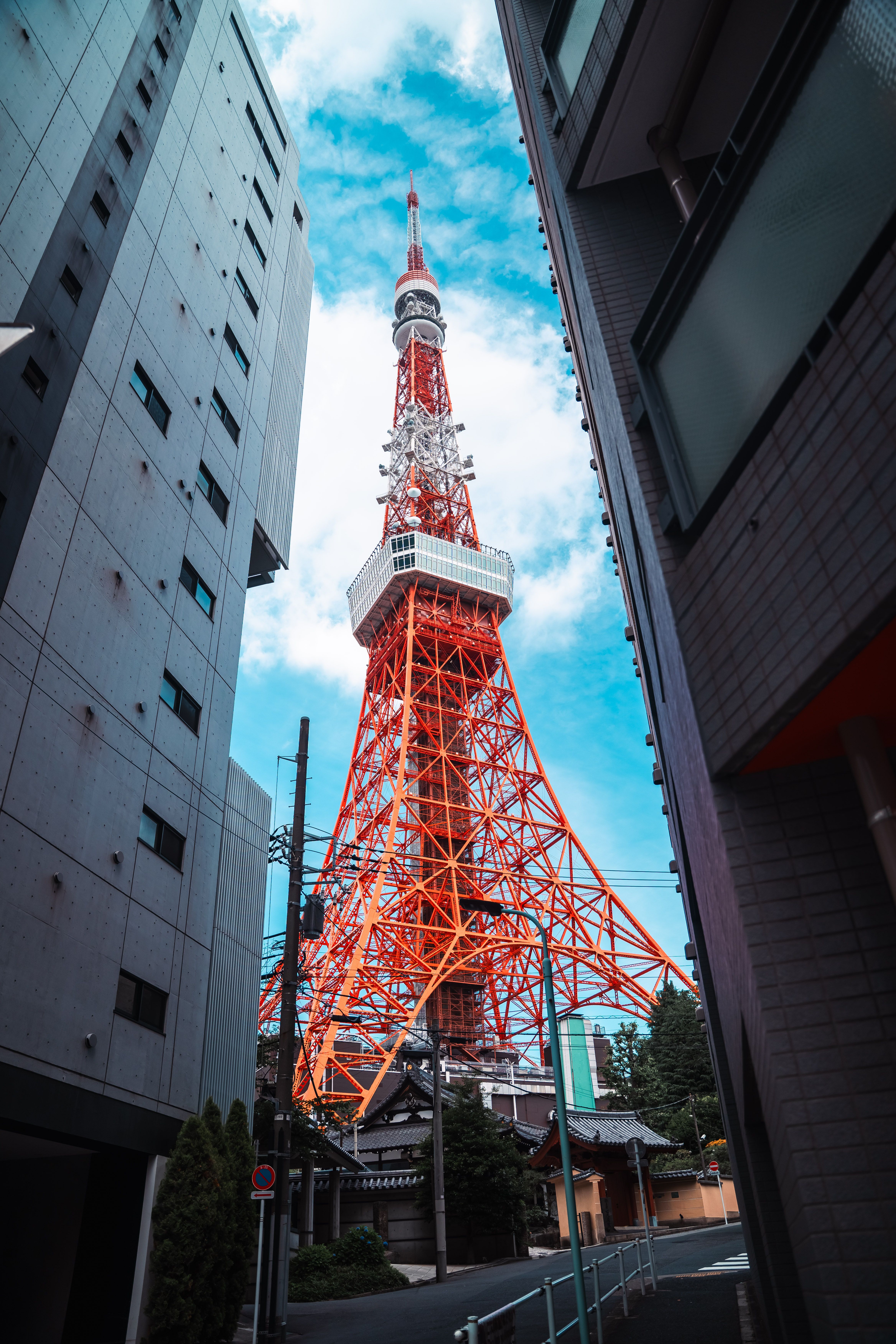Stunning View of Tokyo Tower Framed by Urban Buildings · Free Stock Photo