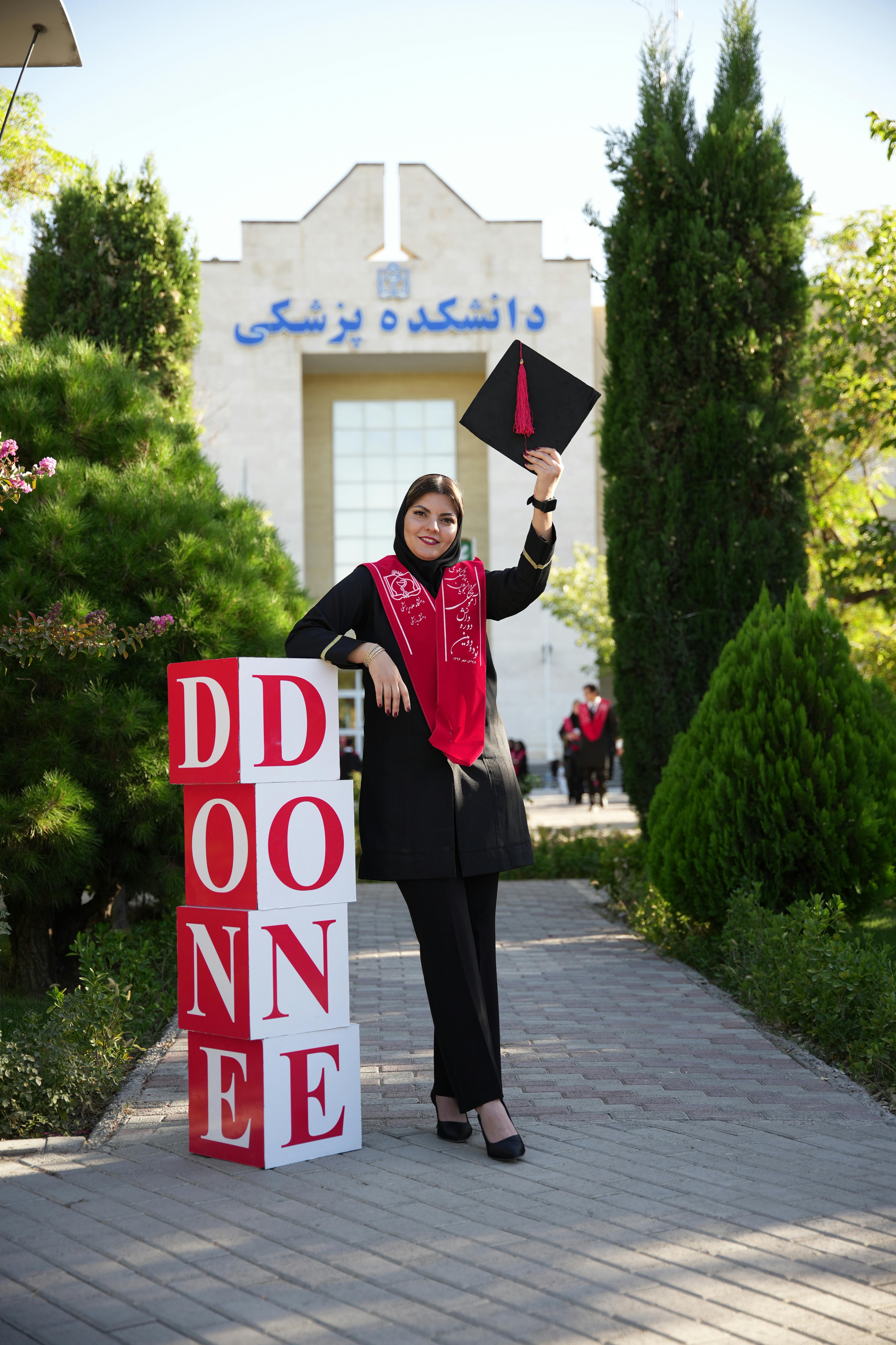 Celebrating Graduation at Medical University Entrance · Free Stock Photo