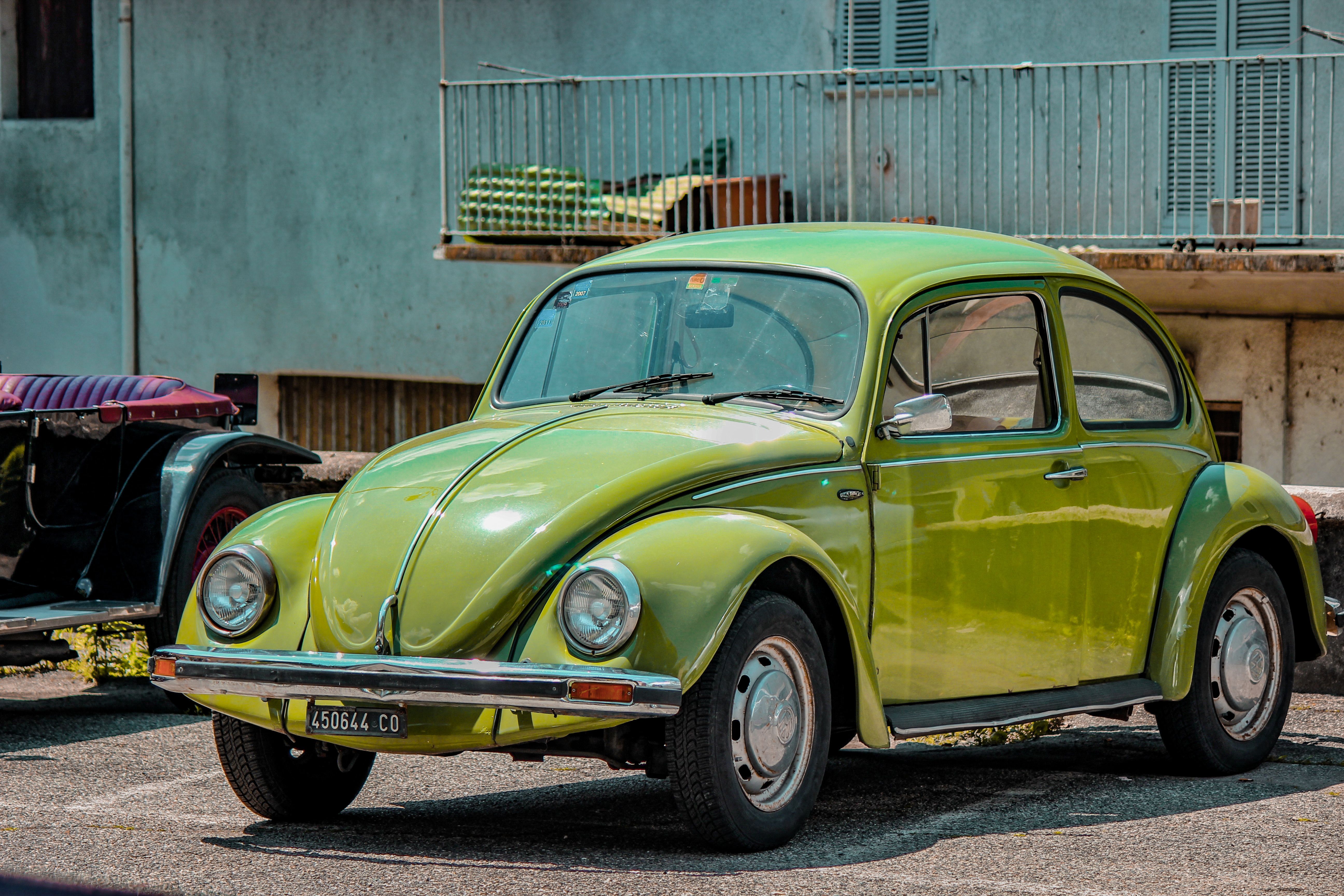 Vintage Green Volkswagen Beetle Parked Outdoors · Free Stock Photo
