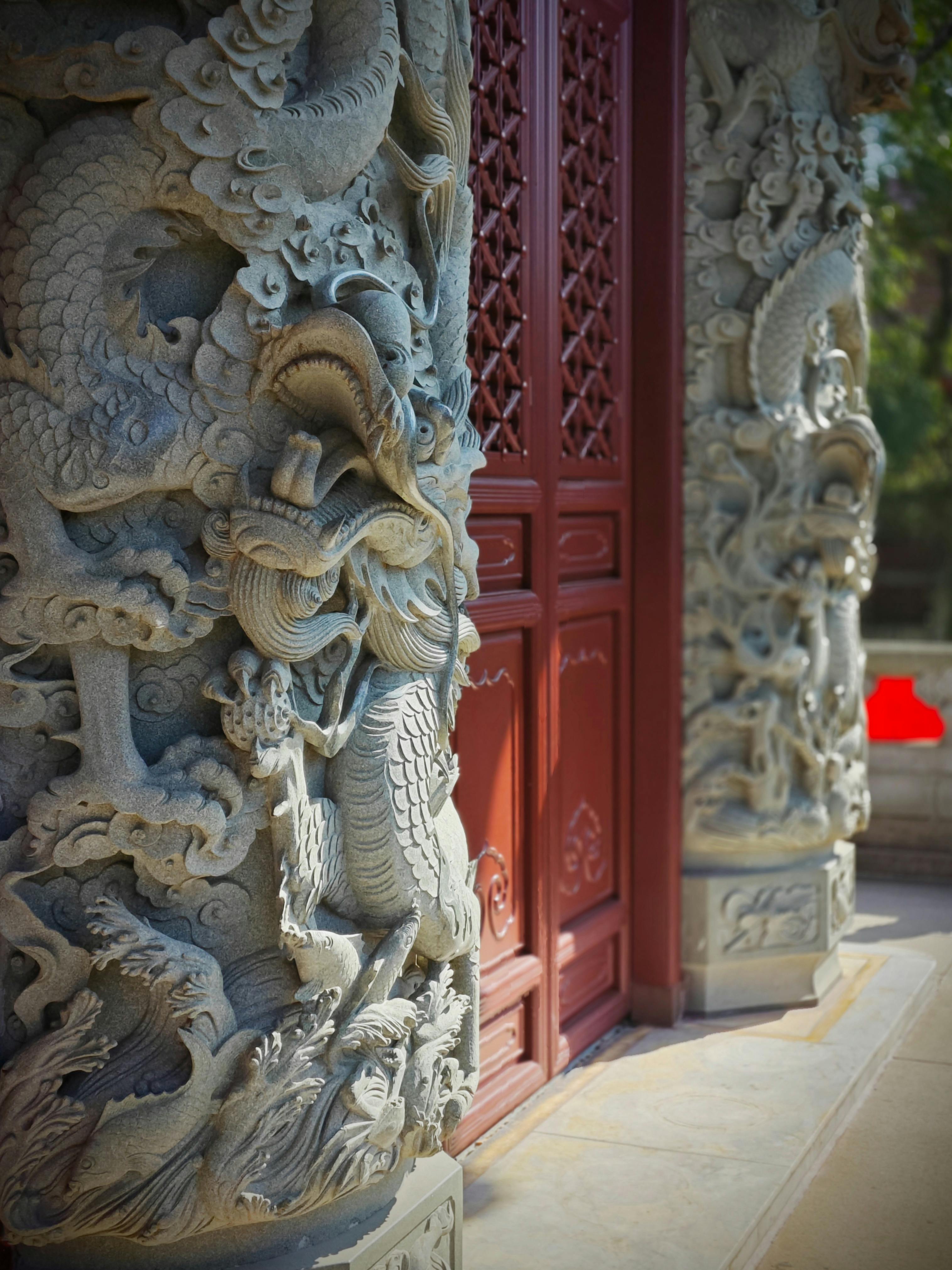 Intricate Dragon Carvings on Ancient Temple Column · Free Stock Photo