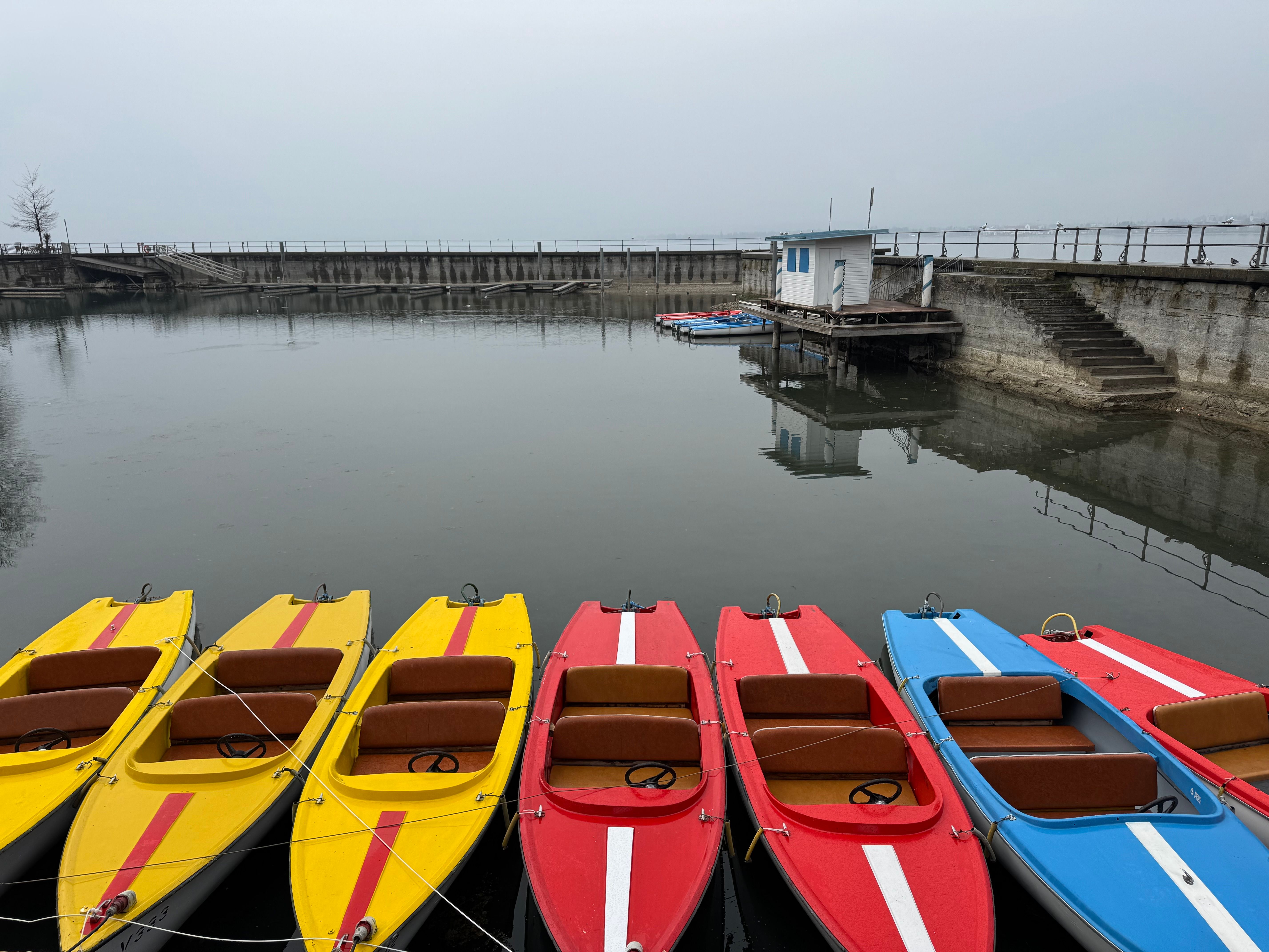 Colorful Boats Docked at a Calm Pier · Free Stock Photo