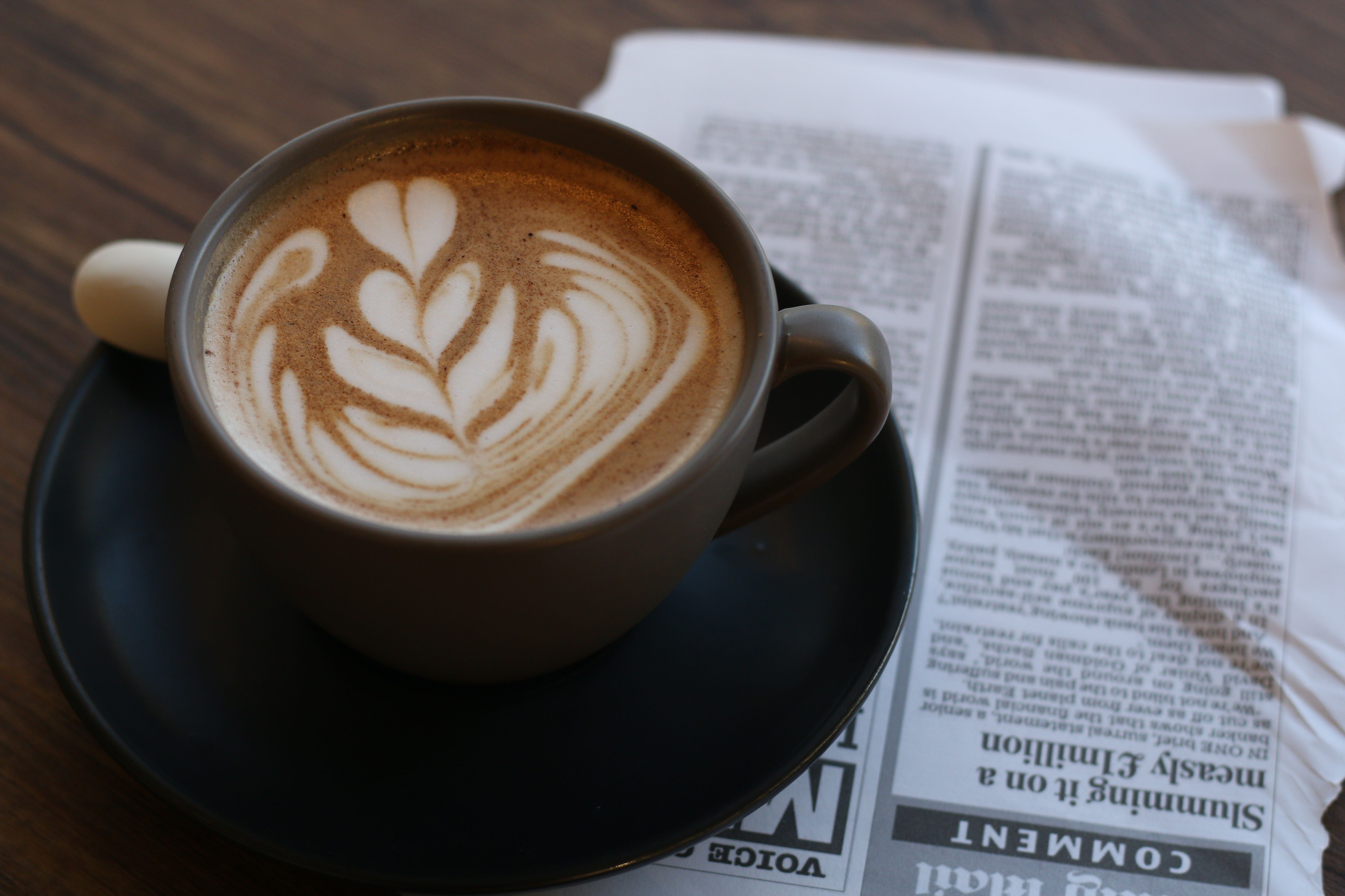 Beautiful Latte Art with Newspaper Background · Free Stock Photo