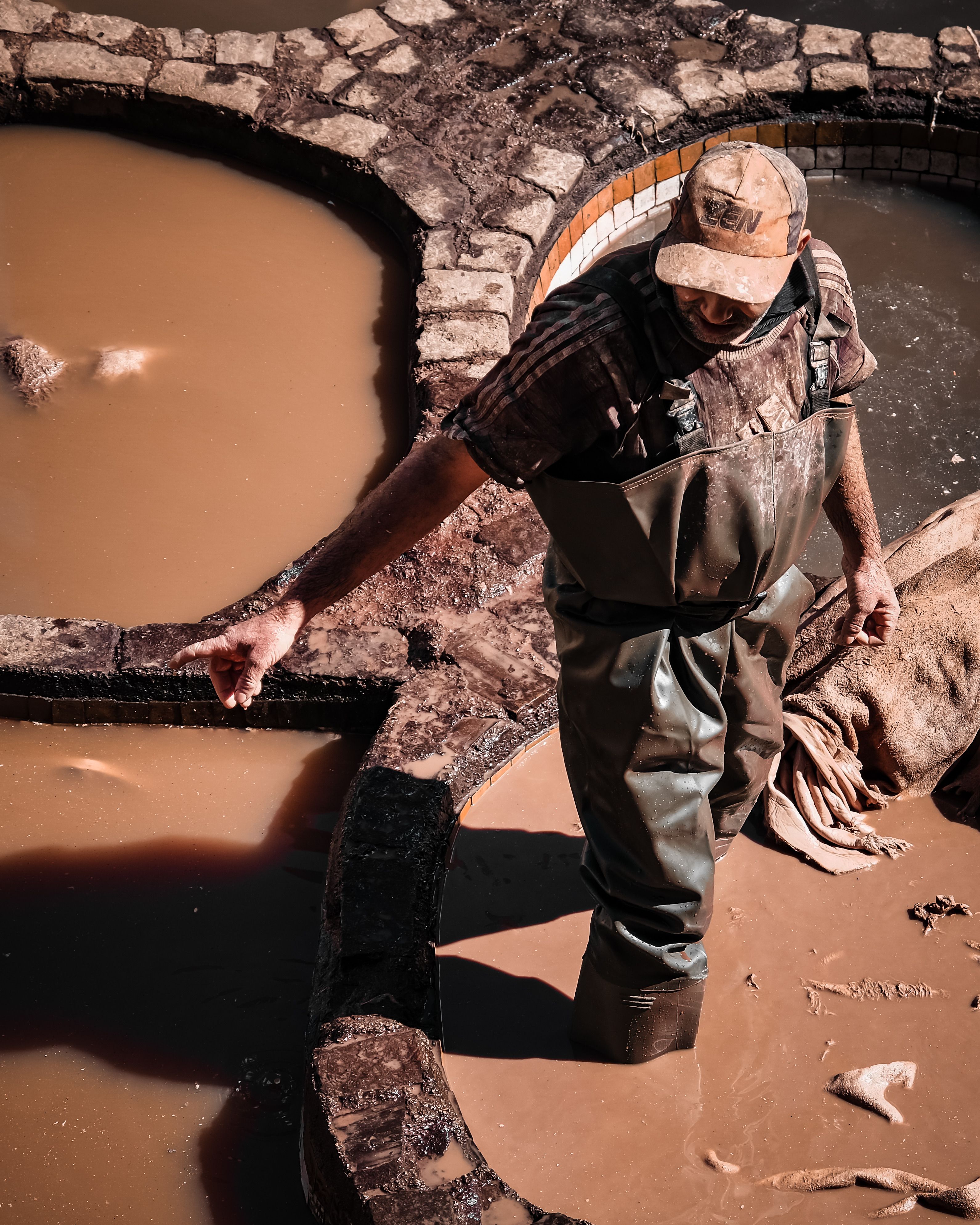 Worker in Traditional Tannery Pit Outdoors · Free Stock Photo