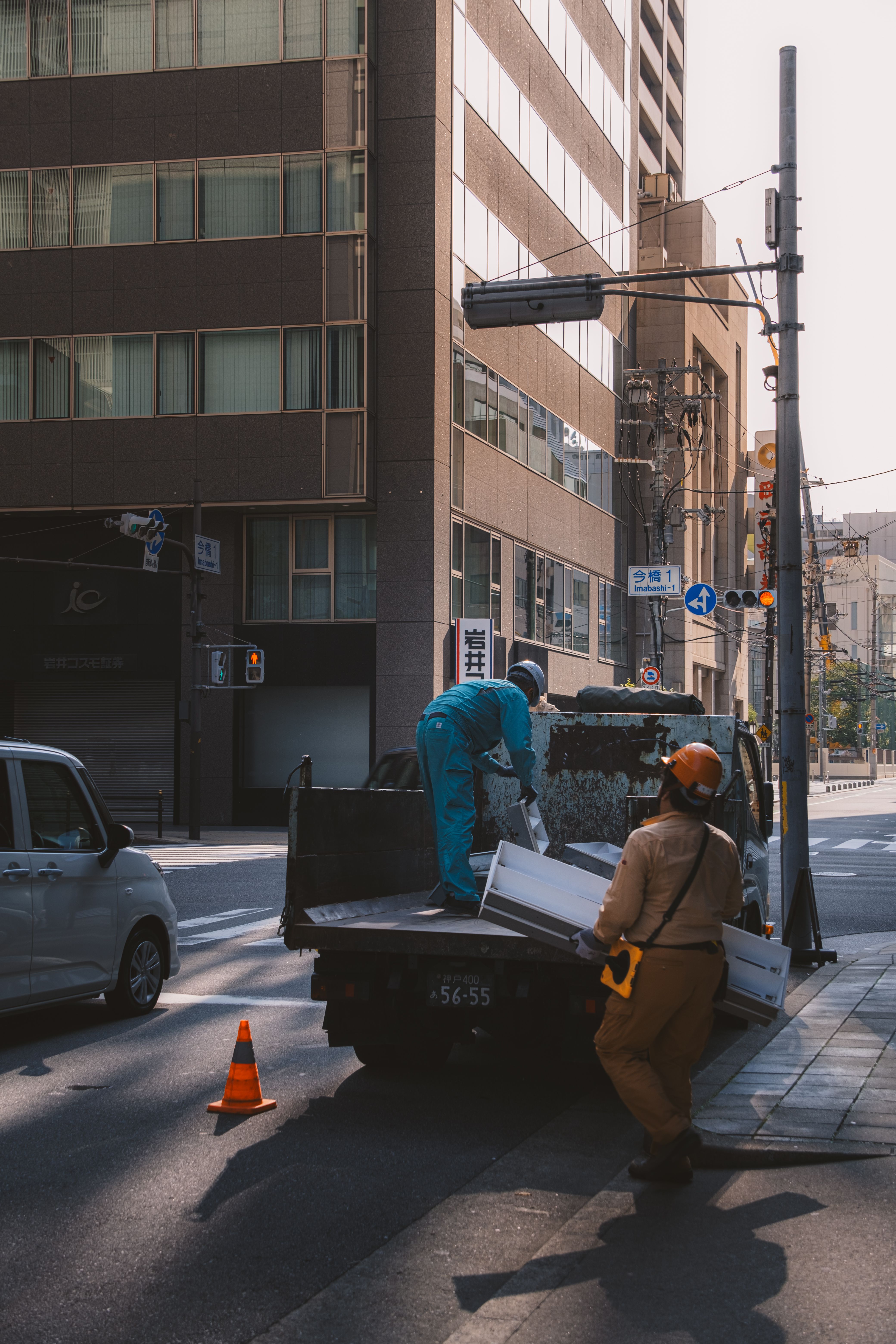 Urban Workers Loading Truck on City Street · Free Stock Photo