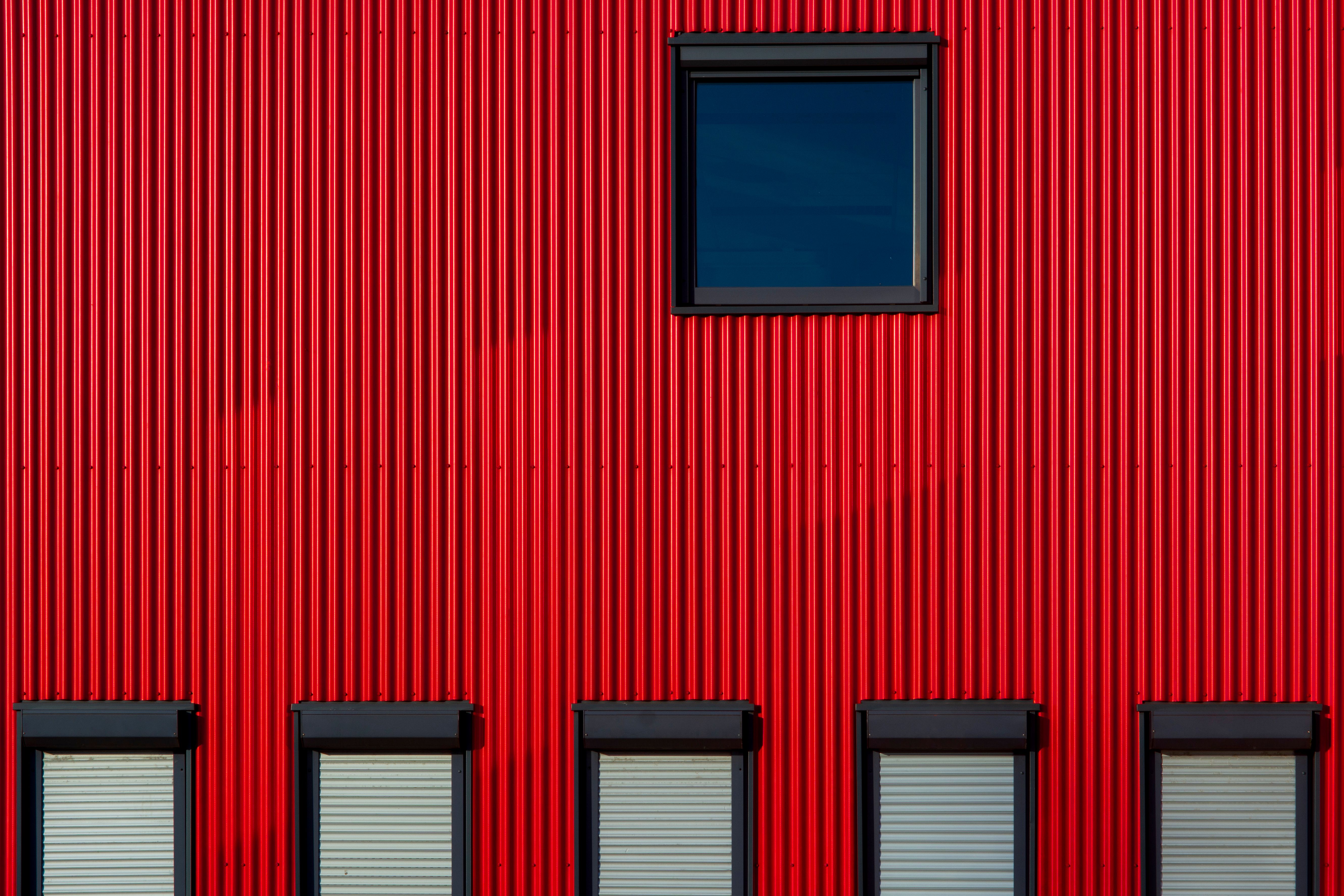 Modern Red Facade with Windows and Shutters · Free Stock Photo