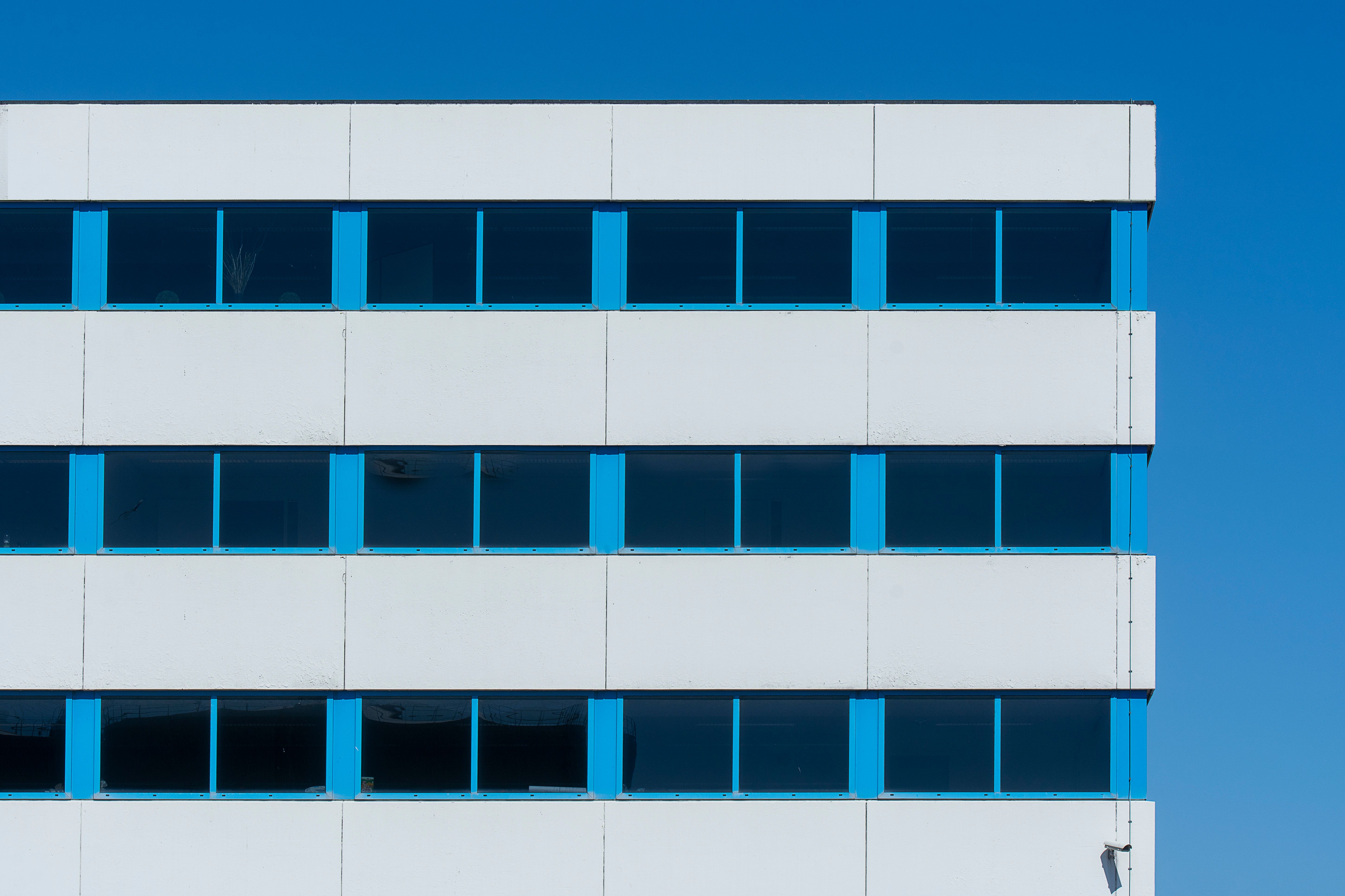 Modern Building Facade with Blue Windows · Free Stock Photo