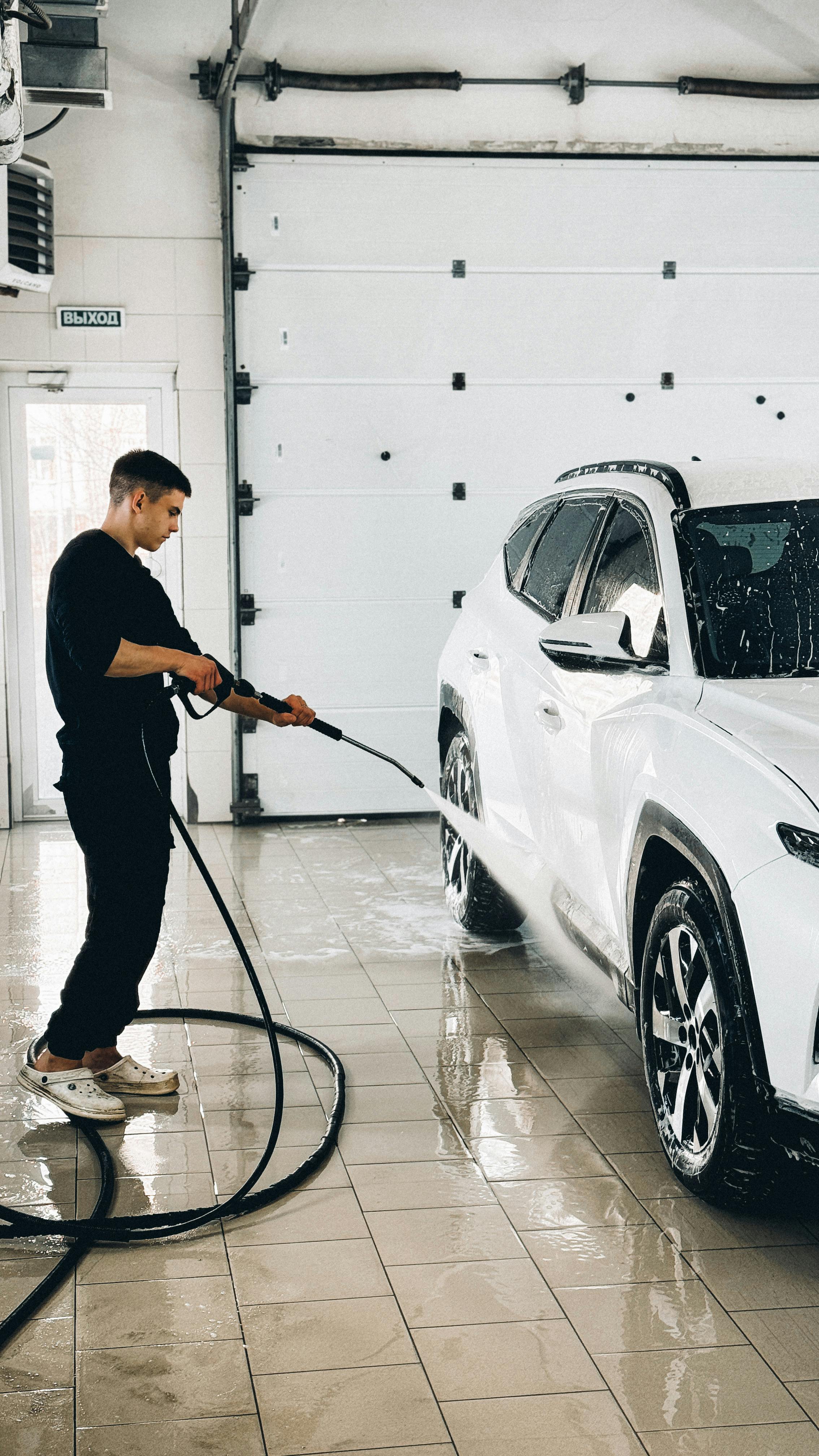 Man Power Washing a Car in Garage · Free Stock Photo
