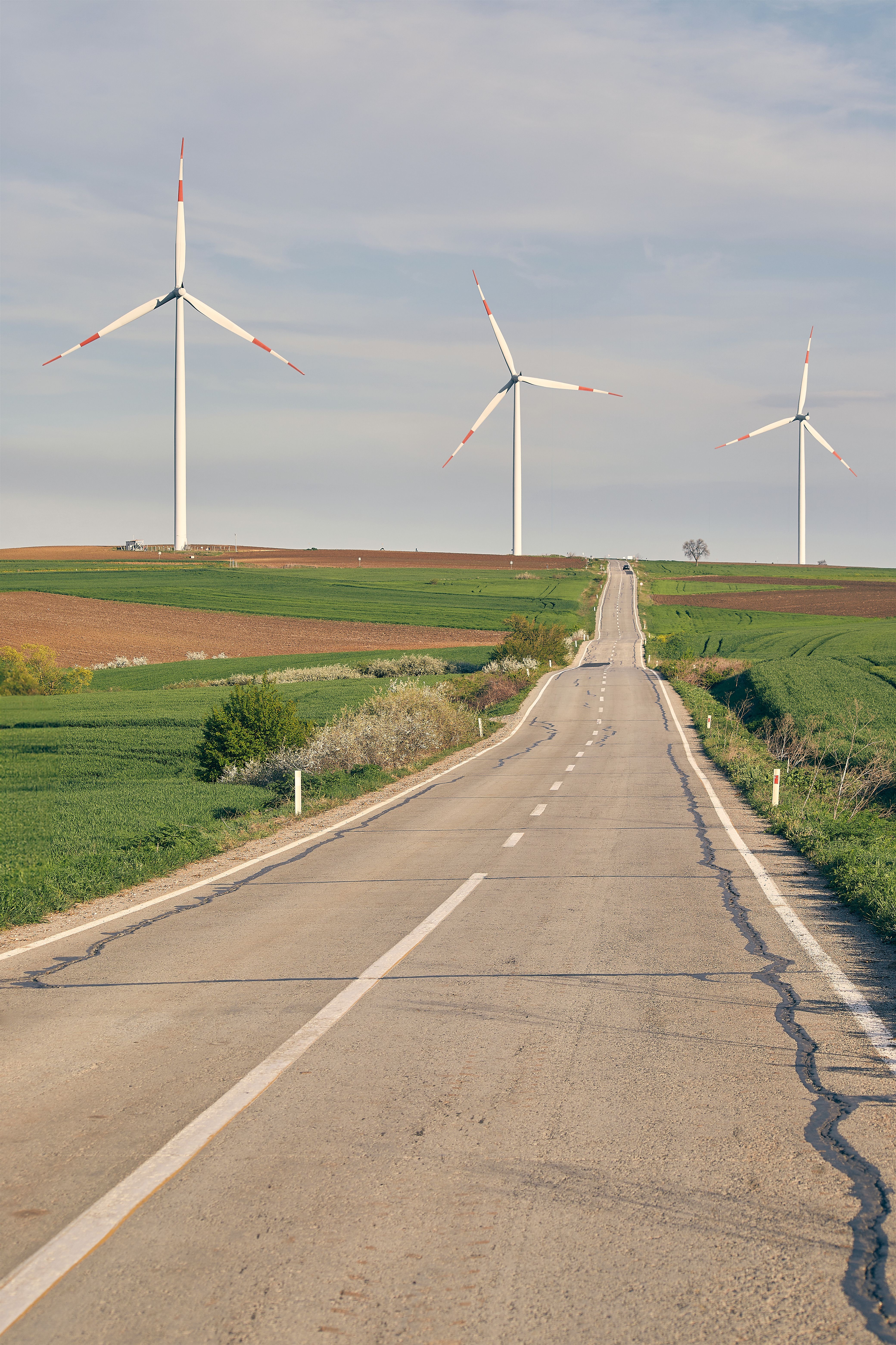 Scenic Road with Wind Turbines in Rural Landscape · Free Stock Photo
